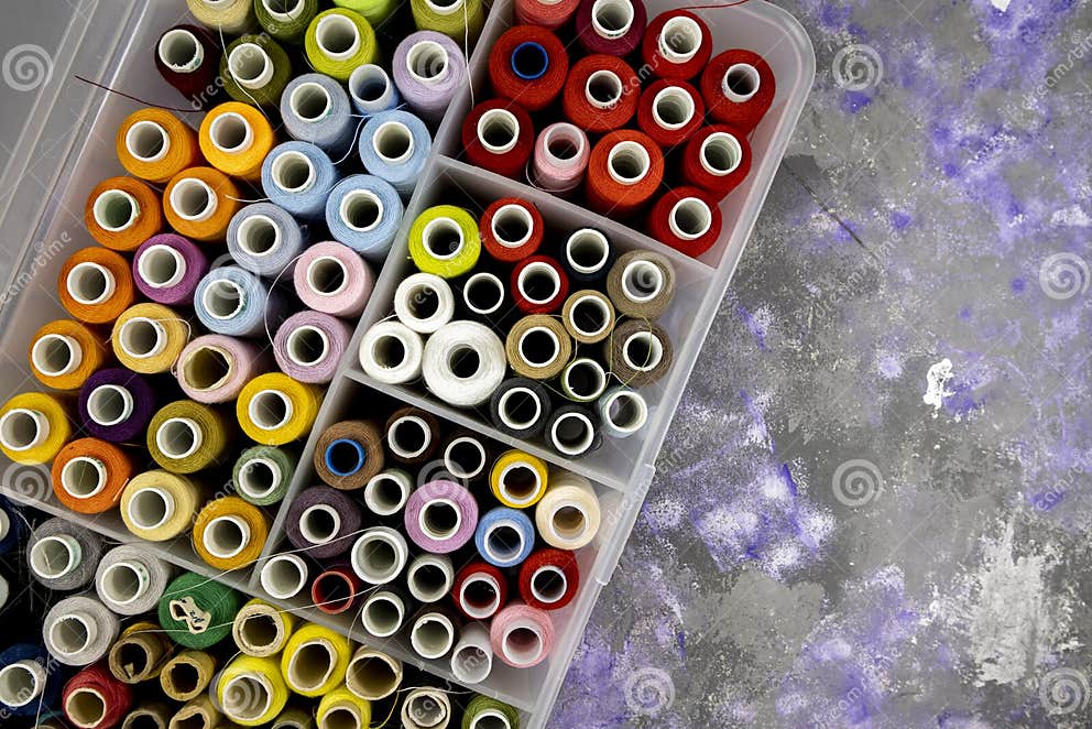 Spools of Bright Colored Threads in a Box on an Abstract Background ...