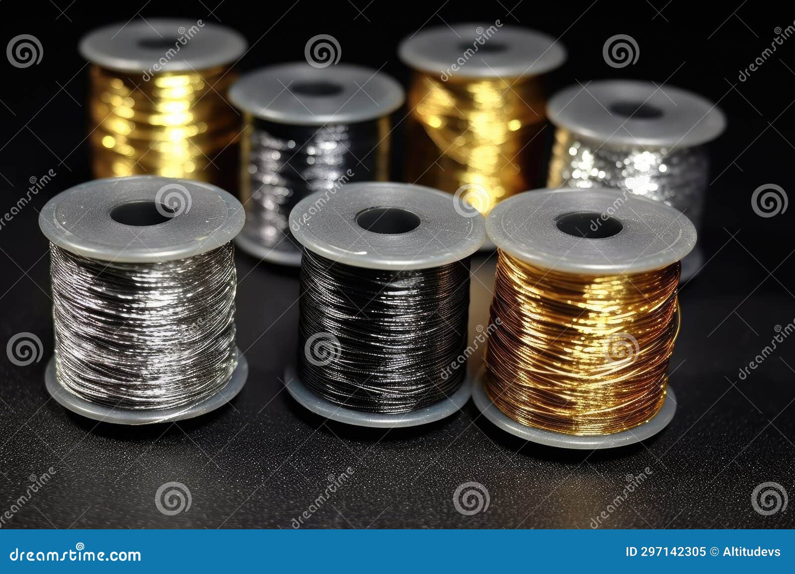 Spools of Gold and Silver Metallic Threads on a Dark Table Stock Image ...