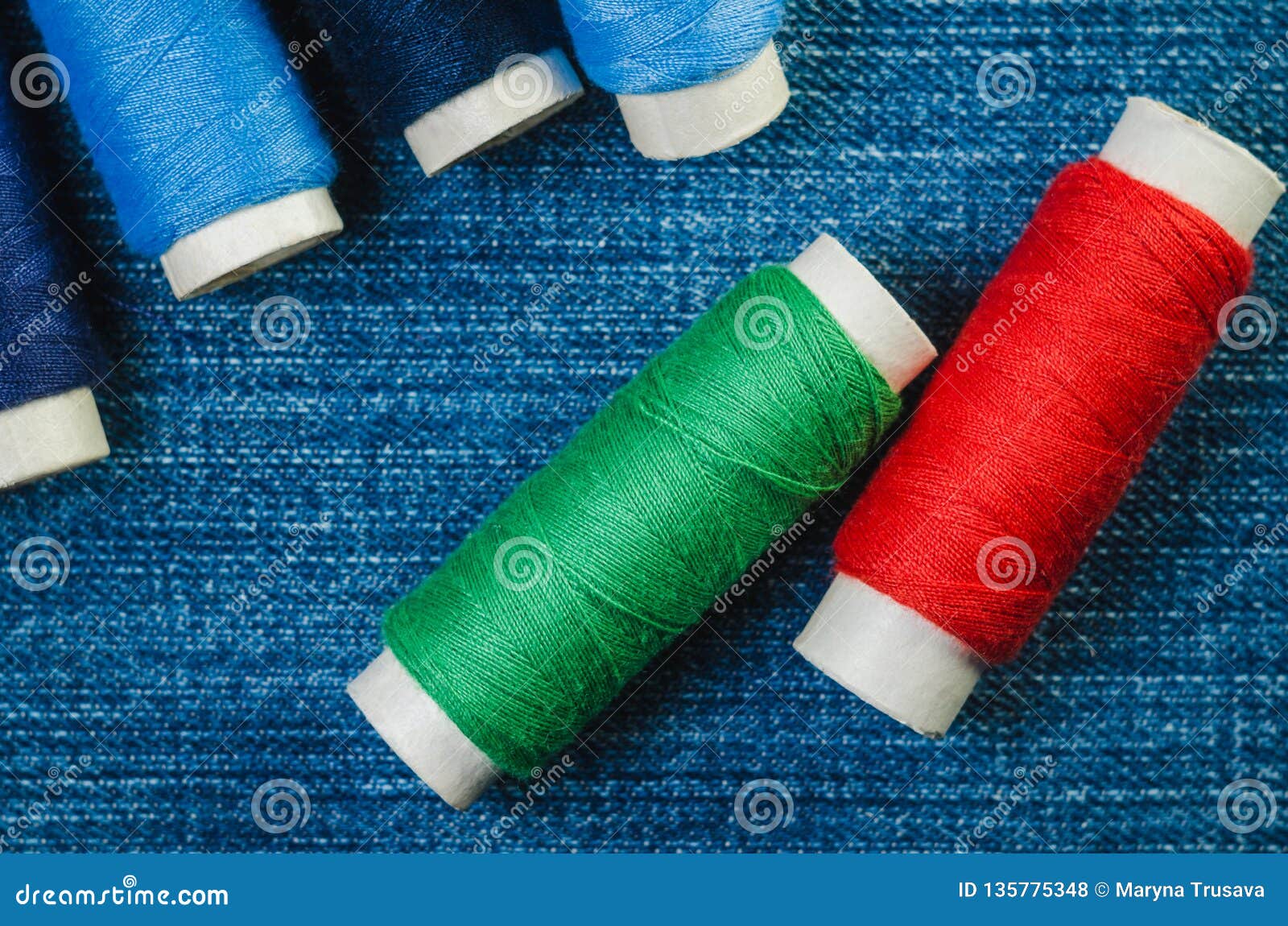 Spools of Green, Red and Blue Threads on Denim Stock Photo - Image of ...