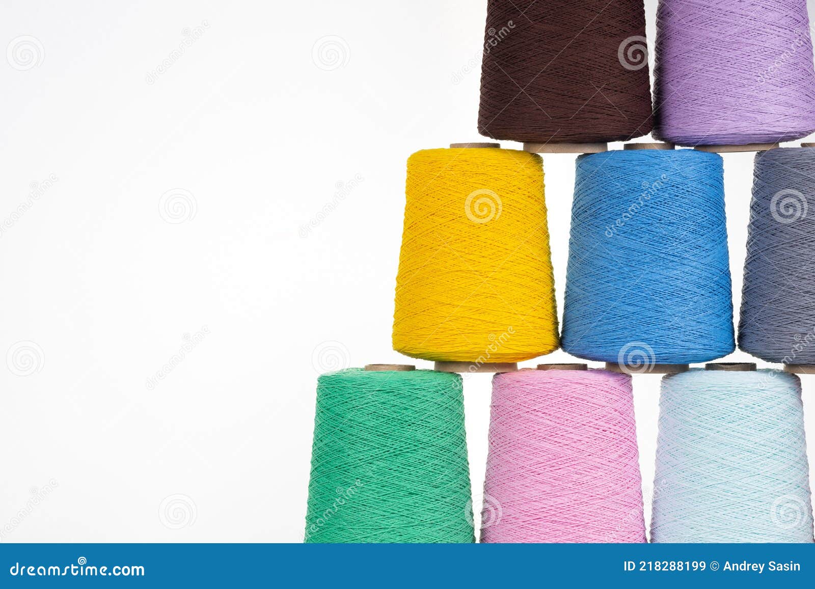 Spools of Multicolored Cotton Thread on a White Background Lined Up in ...