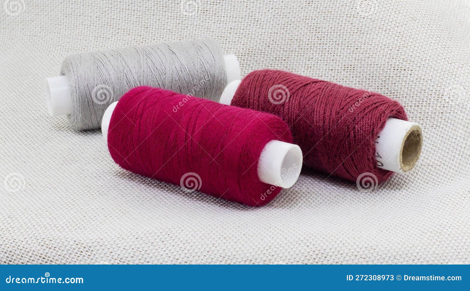 Spools of Red, Burgundy and Gray Threads Lie on the Fabric Stock Image ...