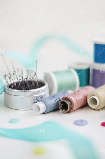 Spools of Thread and Basic Sewing Tools Including Pins, Needle, a ...