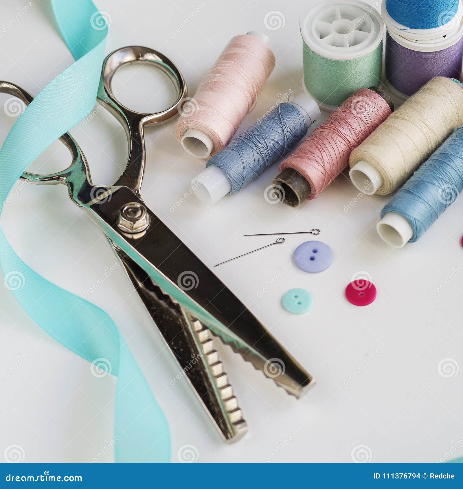 Spools of Thread and Basic Sewing Tools Including Pins, Needle, a ...