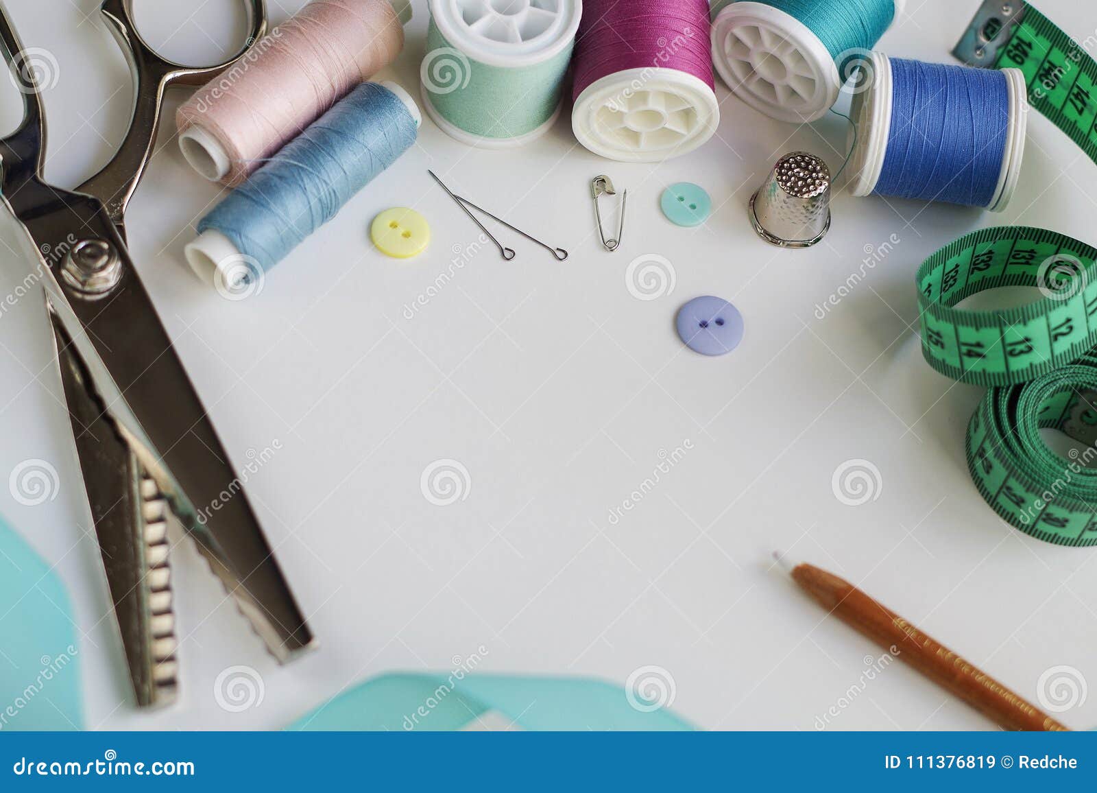 Spools of Thread and Basic Sewing Tools Including Pins, Needle, a ...