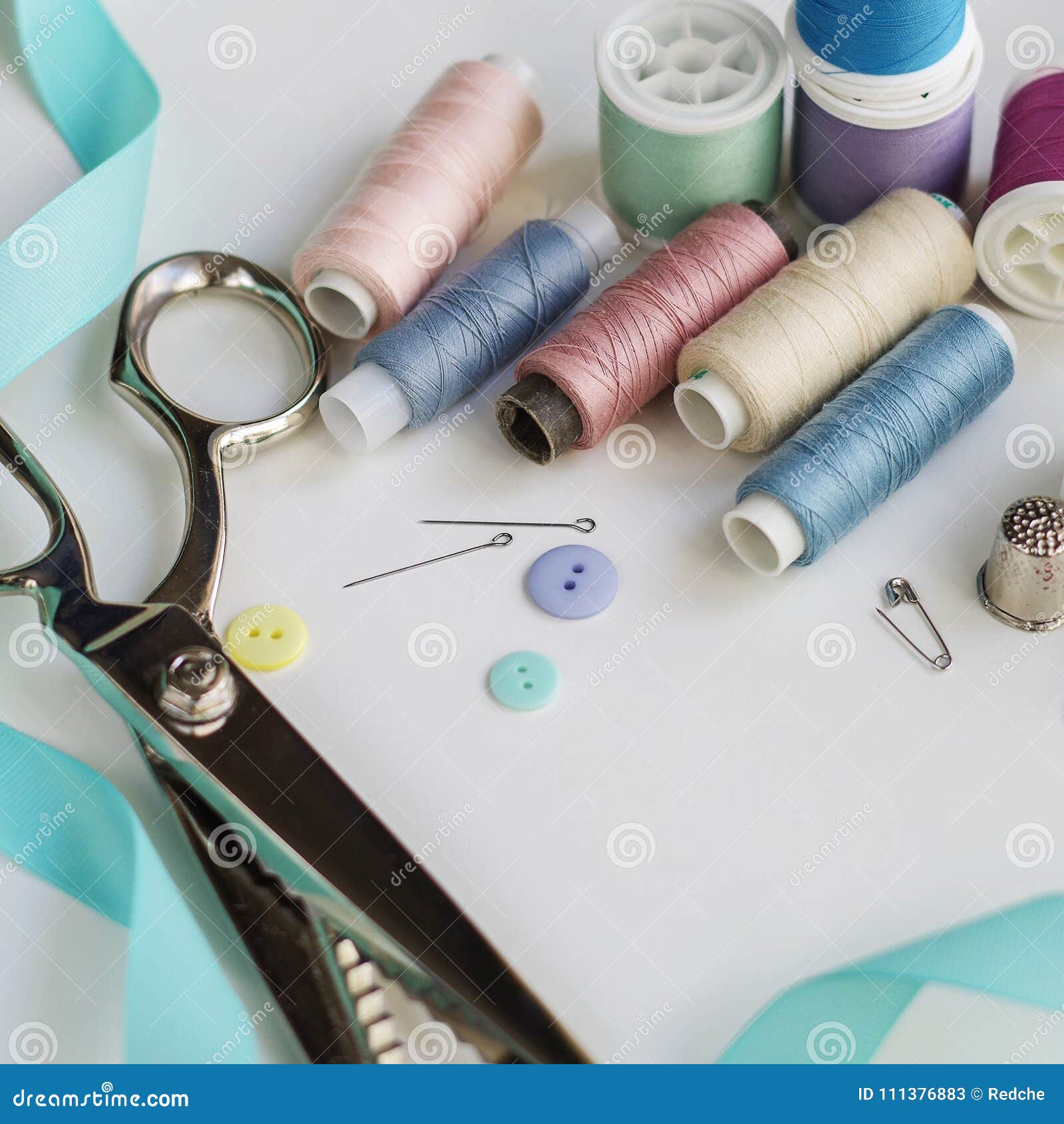 Spools of Thread and Basic Sewing Tools Including Pins, Needle, a ...