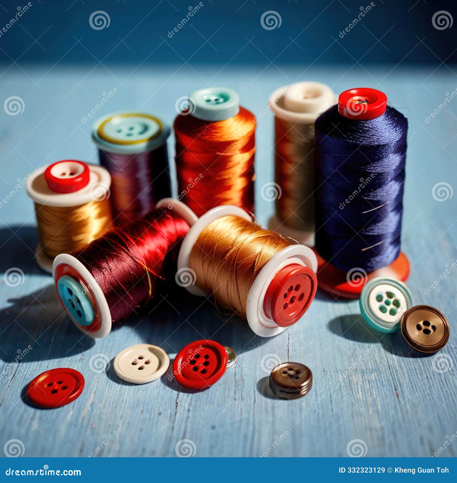 Spools of Thread and Buttons on Light Blue Background Stock ...