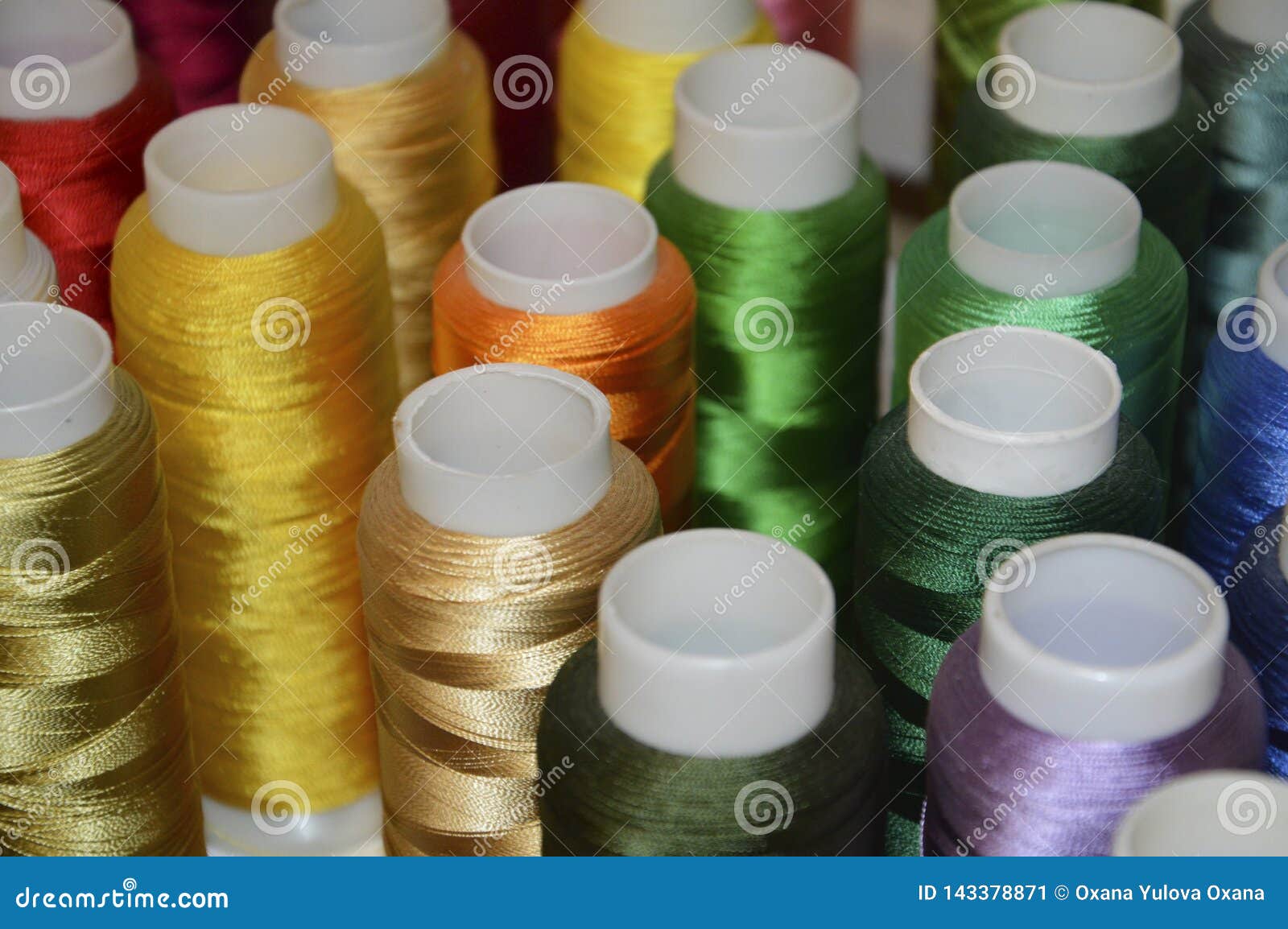 Spools of thread stock image. Image of golden, yellow - 143378871
