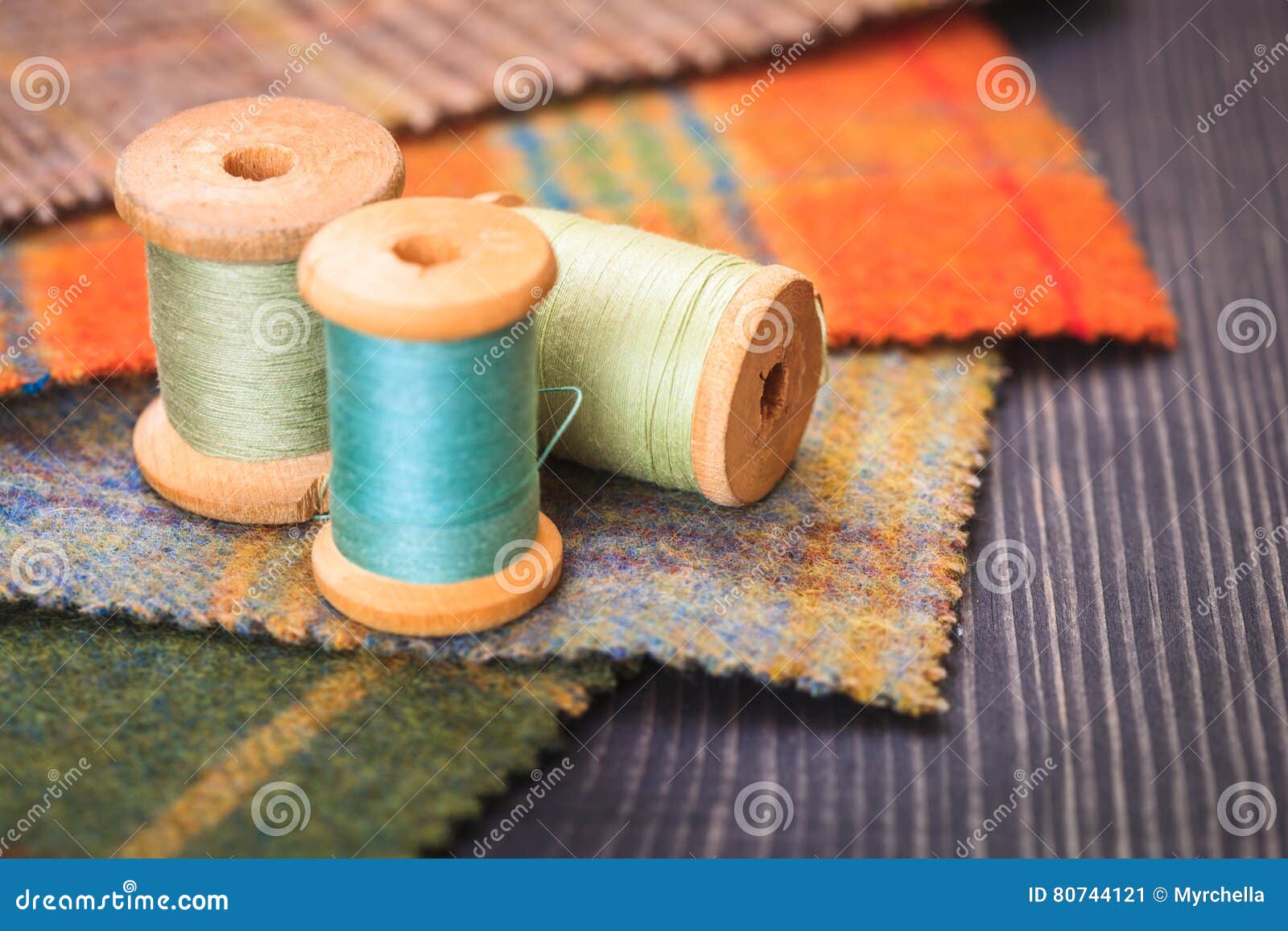Spools of Thread and Fabric Swatches on the Table Stock Image - Image ...