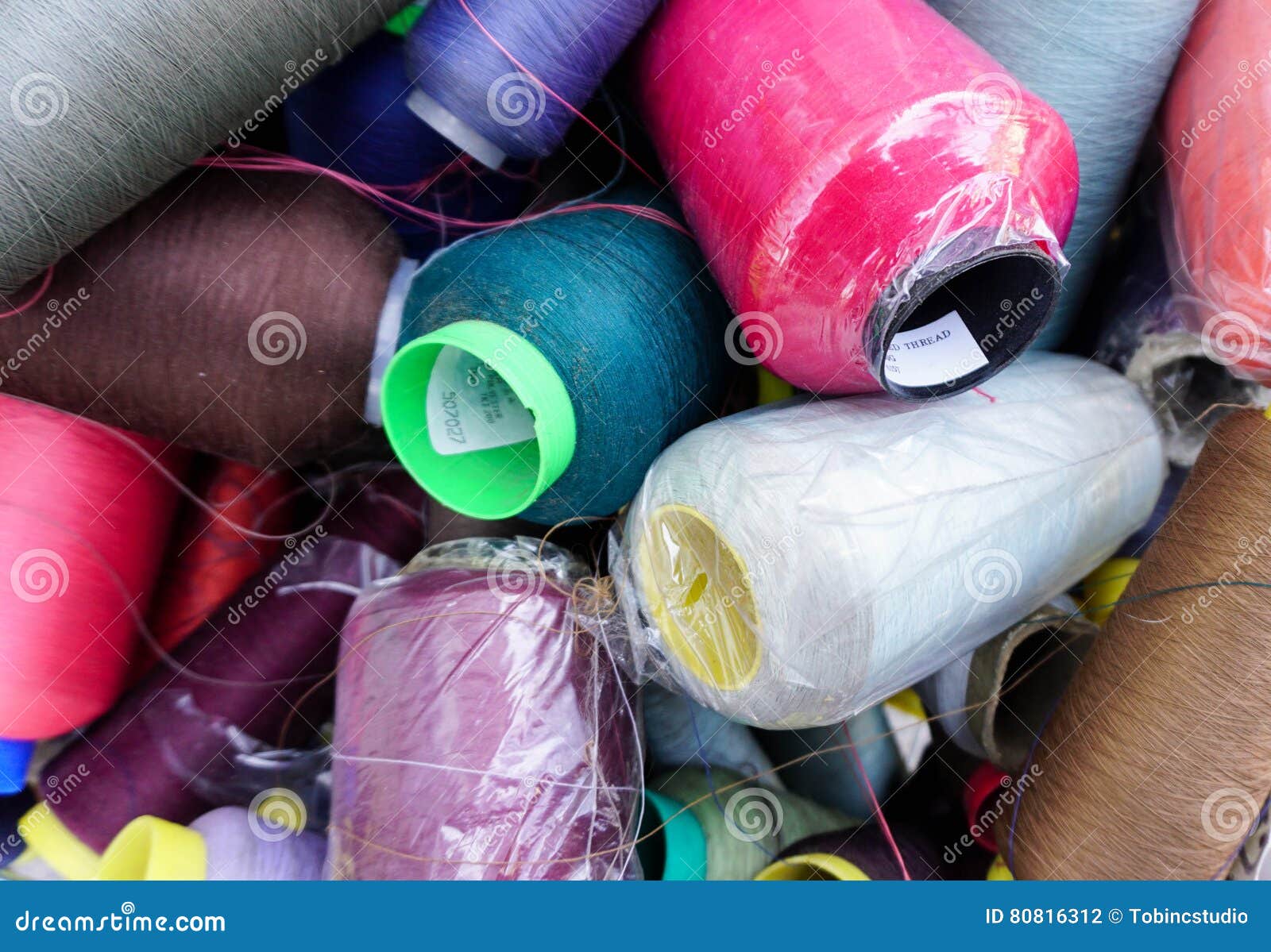 Spools of thread in a pile stock photo. Image of curtain - 80816312