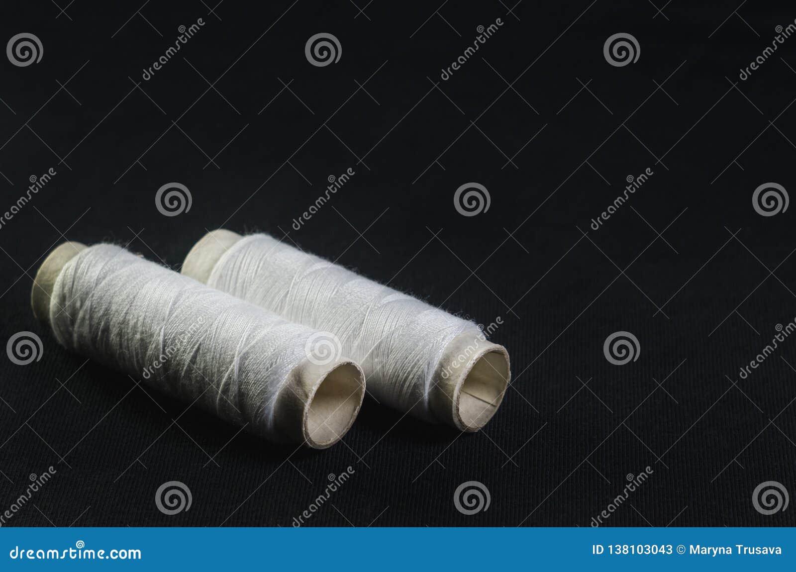 Spools of White Threads on Black Fabric with Copy Space Stock Image ...