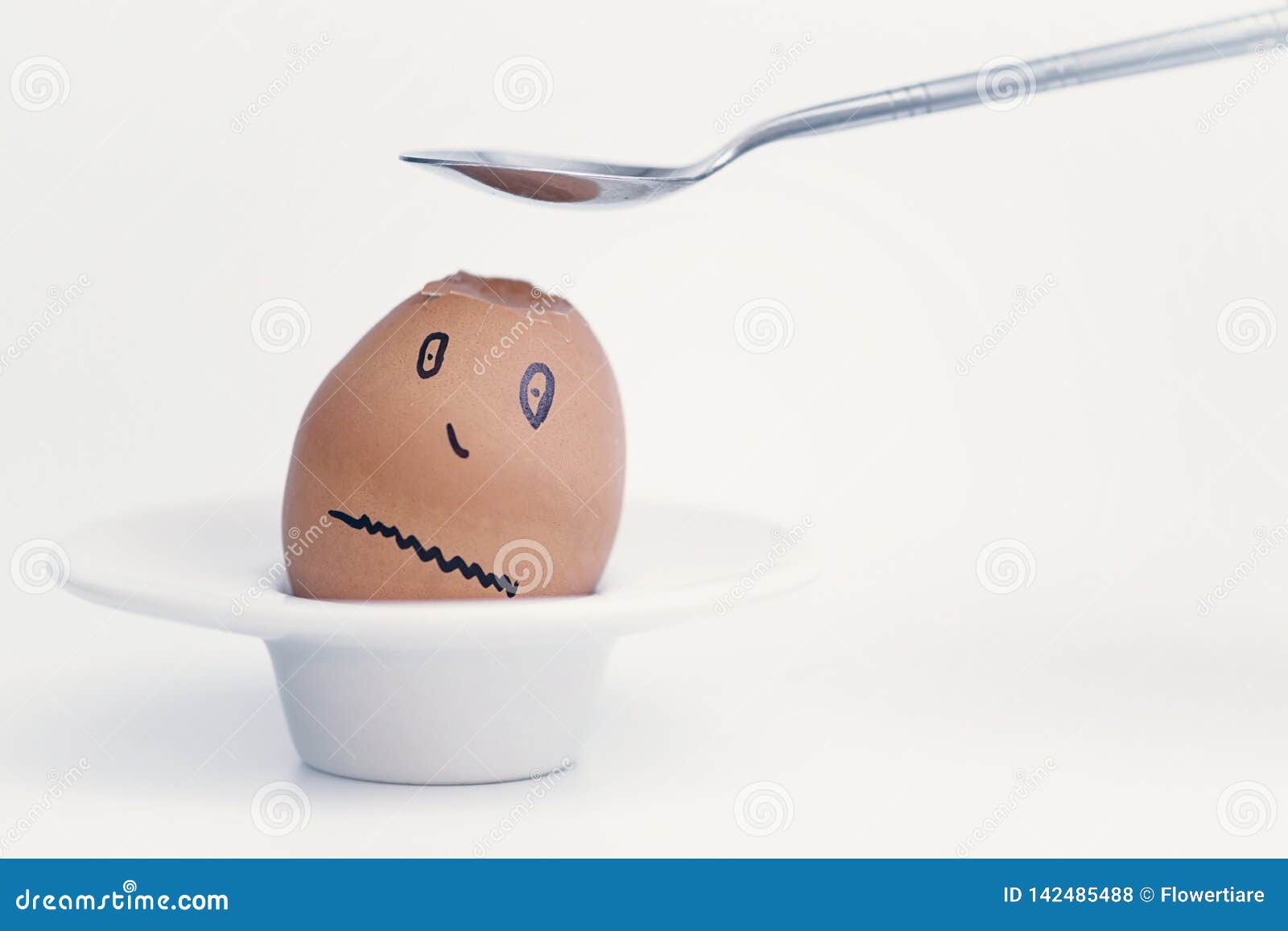 Spoon Breaks Sad Egg on a Stand in the Form of Human Head . Stock Photo ...