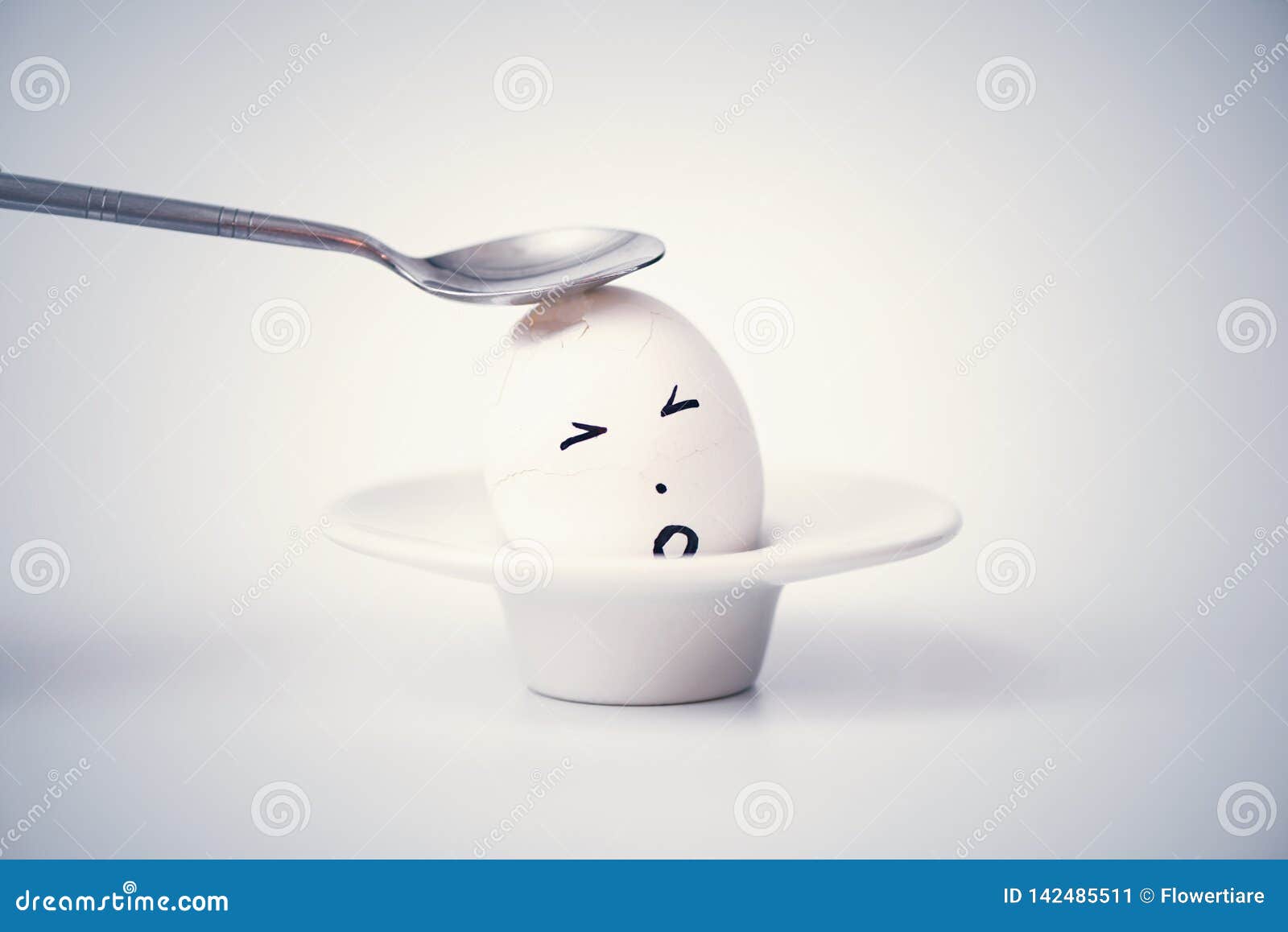 Spoon Breaks Sad Egg on a Stand in the Form of Human Head . Stock Image ...