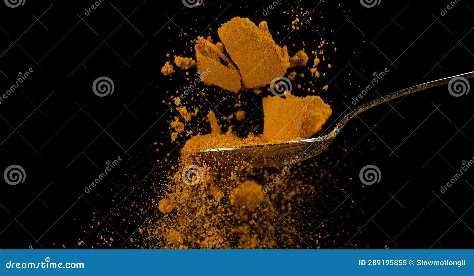 Spoon and Curry Powder Falling from Spoon Against Black Background ...
