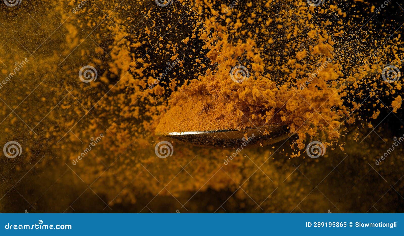 Spoon and Curry Powder Falling from Spoon Against Black Background ...