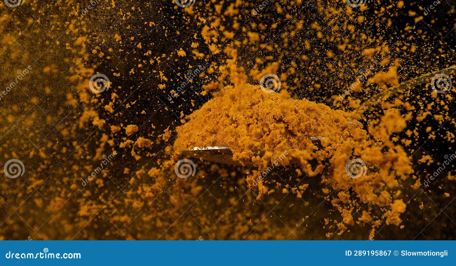 Spoon and Curry Powder Falling from Spoon Against Black Background ...