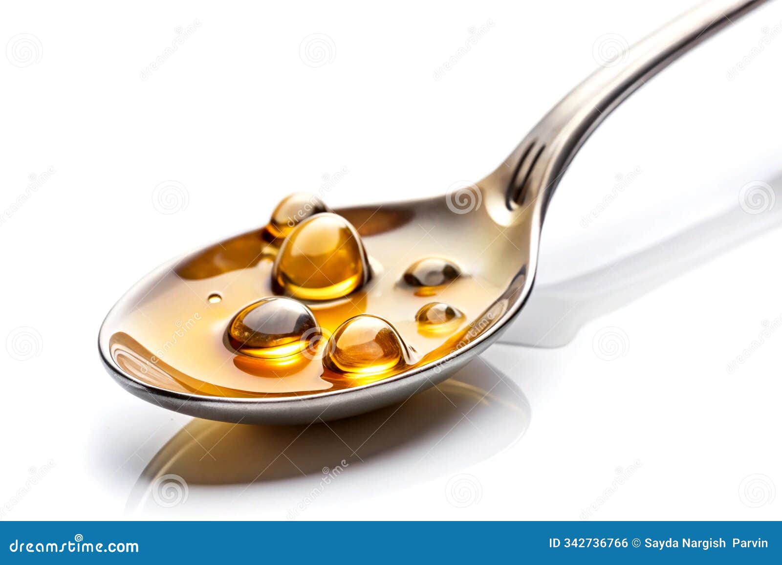 A Spoon with Drops Oil Liquid, Isolated on White Background Stock ...