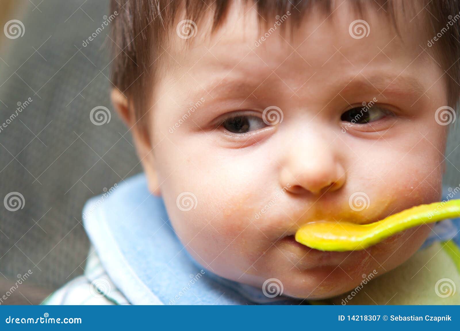 Spoon fed baby stock image. Image of grumpy, details - 14218307