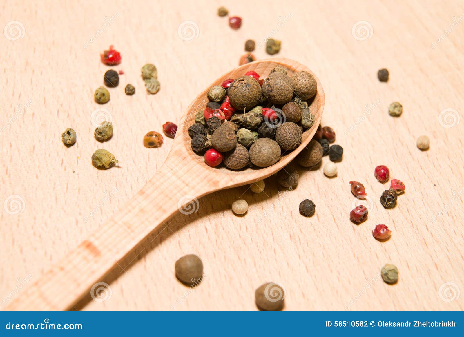 Spoon Filled with Grains of Pepper on a Wooden Surface Stock Photo ...