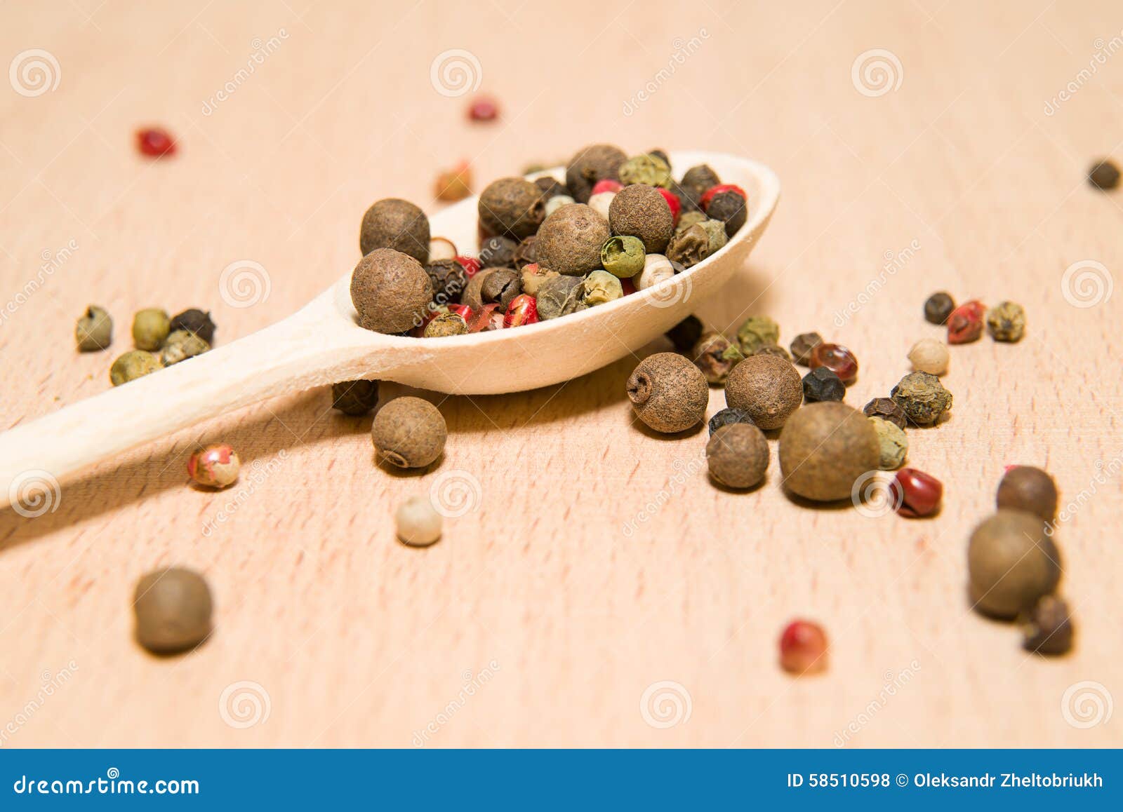 Spoon Filled with Grains of Pepper on a Wooden Surface Stock Photo ...