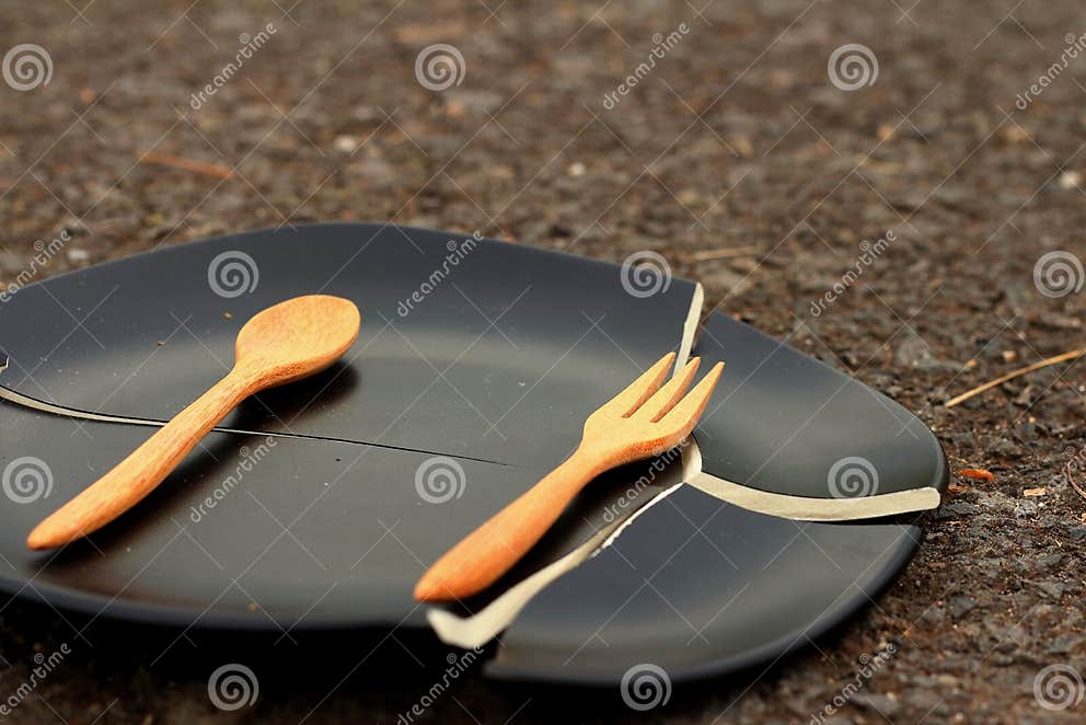 Spoon and Fork on a Crack Black Plate. Stock Image - Image of concept ...