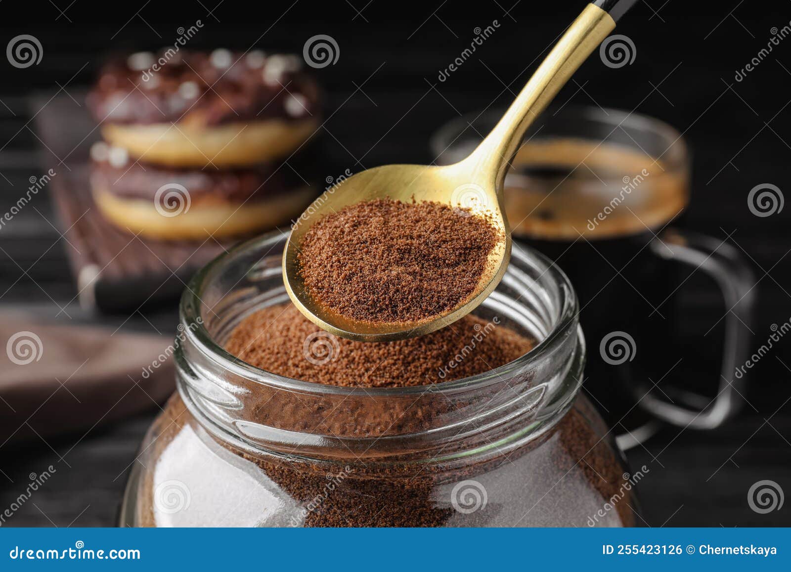 Spoon of Instant Coffee Over Jar on Black Table, Closeup Stock Photo ...