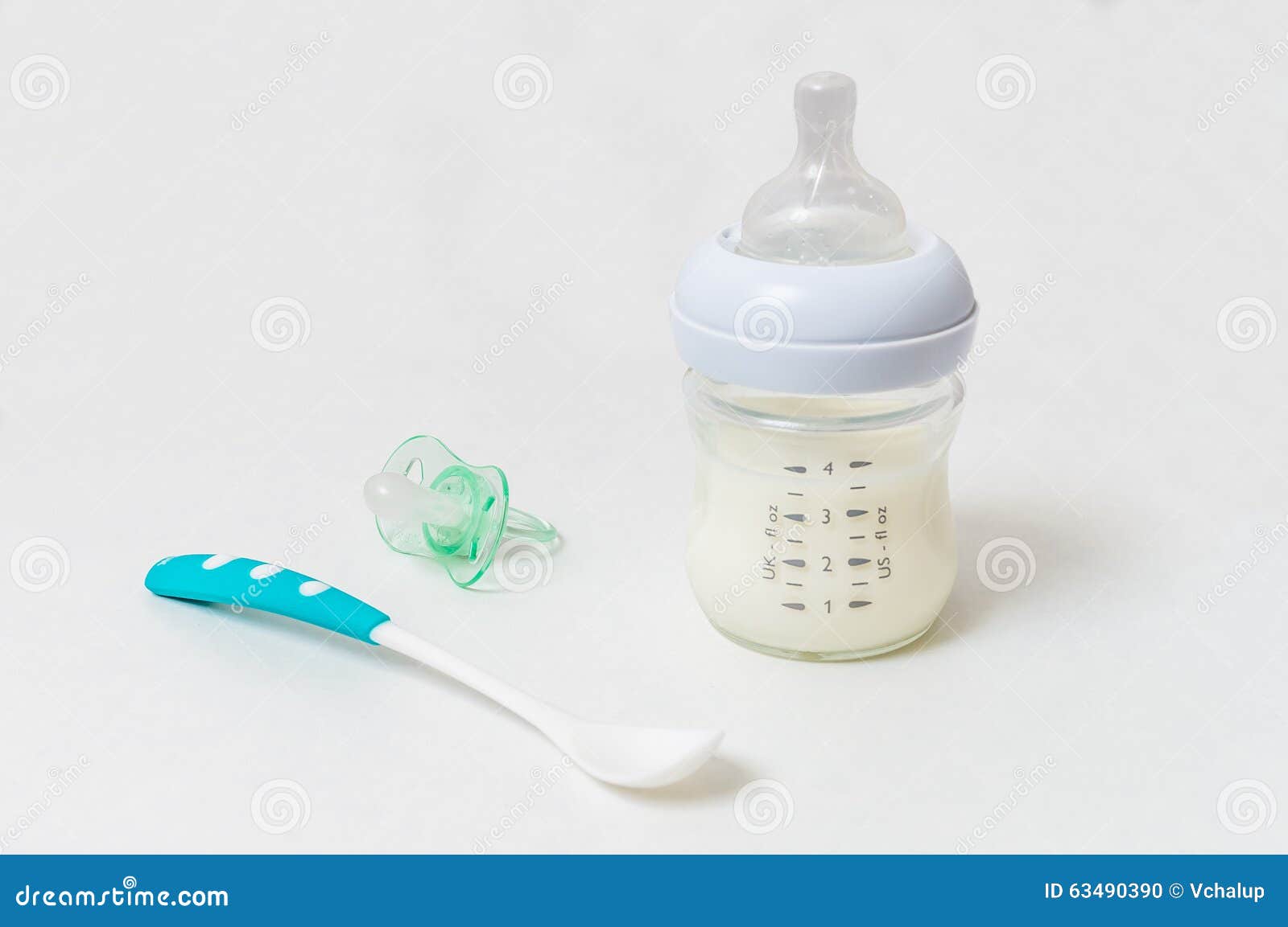 Spoon, Pacifier and Bottle with Milk for Feeding Baby Stock Photo ...