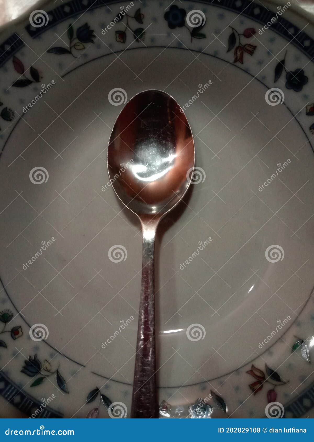 Spoon on plate stock photo. Image of spoon, plate, objects - 202829108