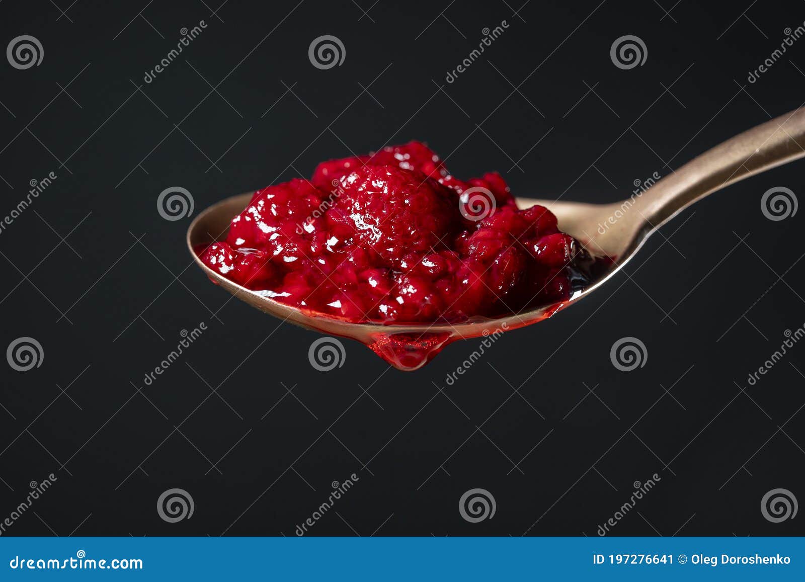 Thick Red Raspberry Jam Dripping from the Spoon, One Drop, on Black ...