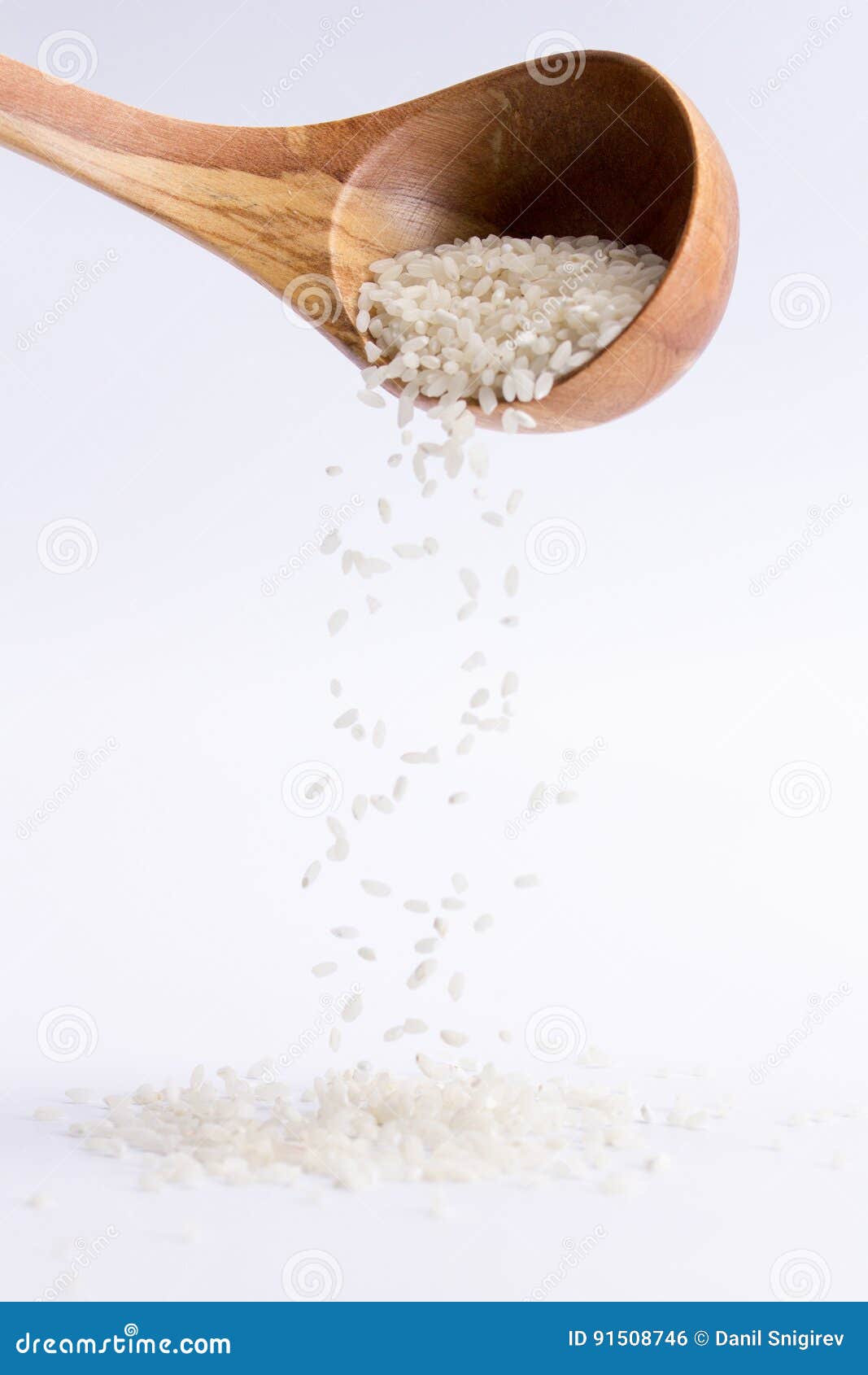 Spoon of Rice Falling on a White Background. Rice Falling Down from a ...