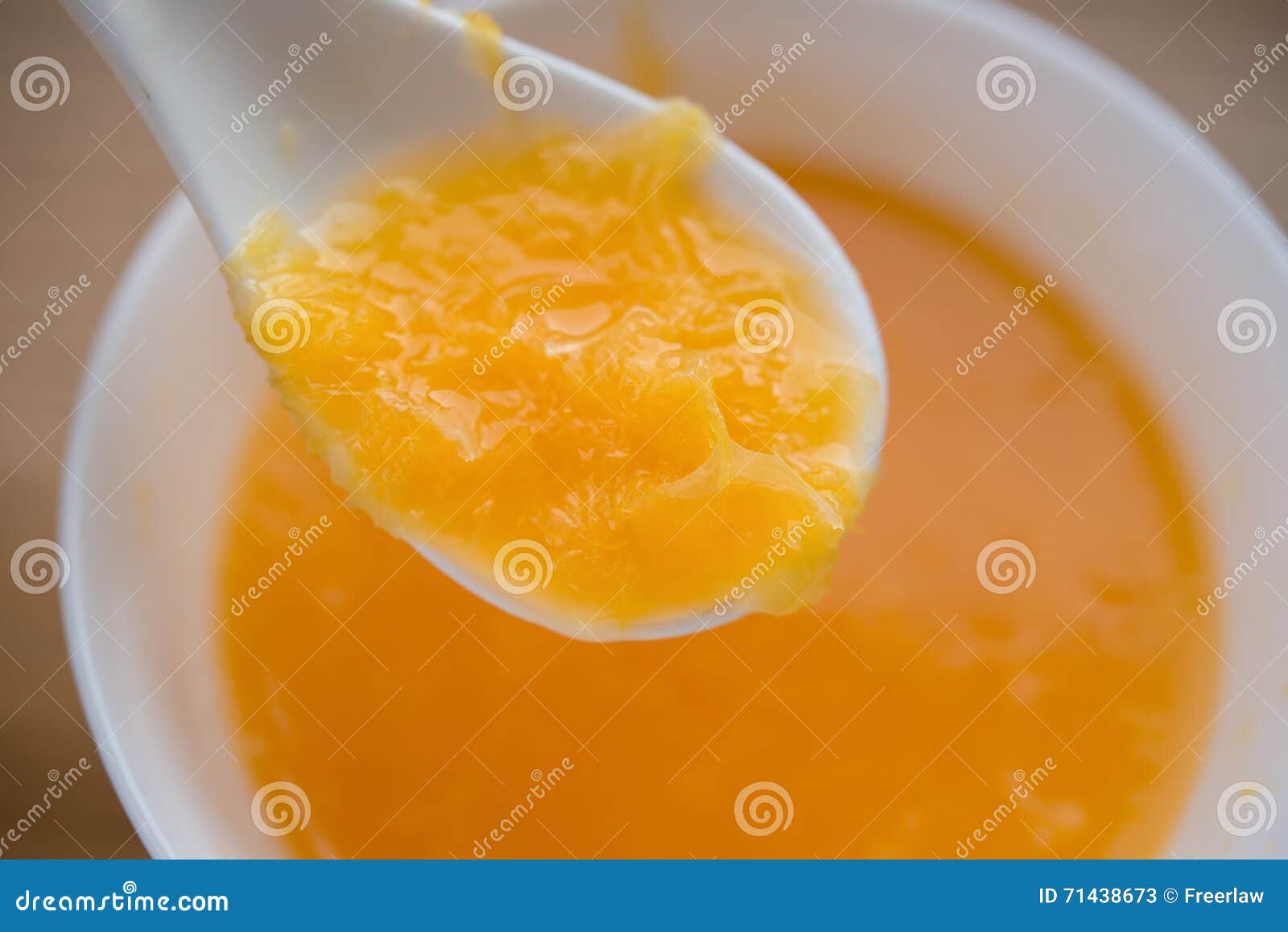 Spoon Taking Out Fresh Orange Juice with a Full Filled Bowl Stock Image ...