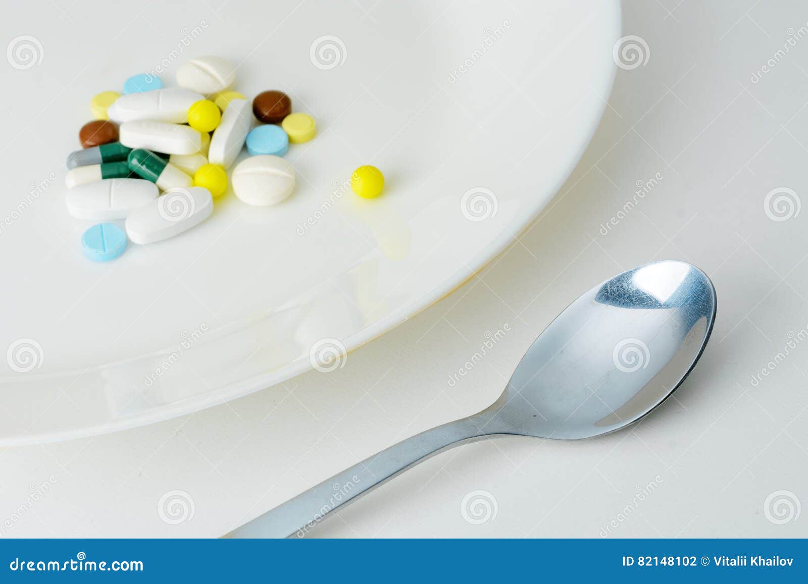Spoon and the White Plate with Tablets of Different Shapes, Sizes and ...