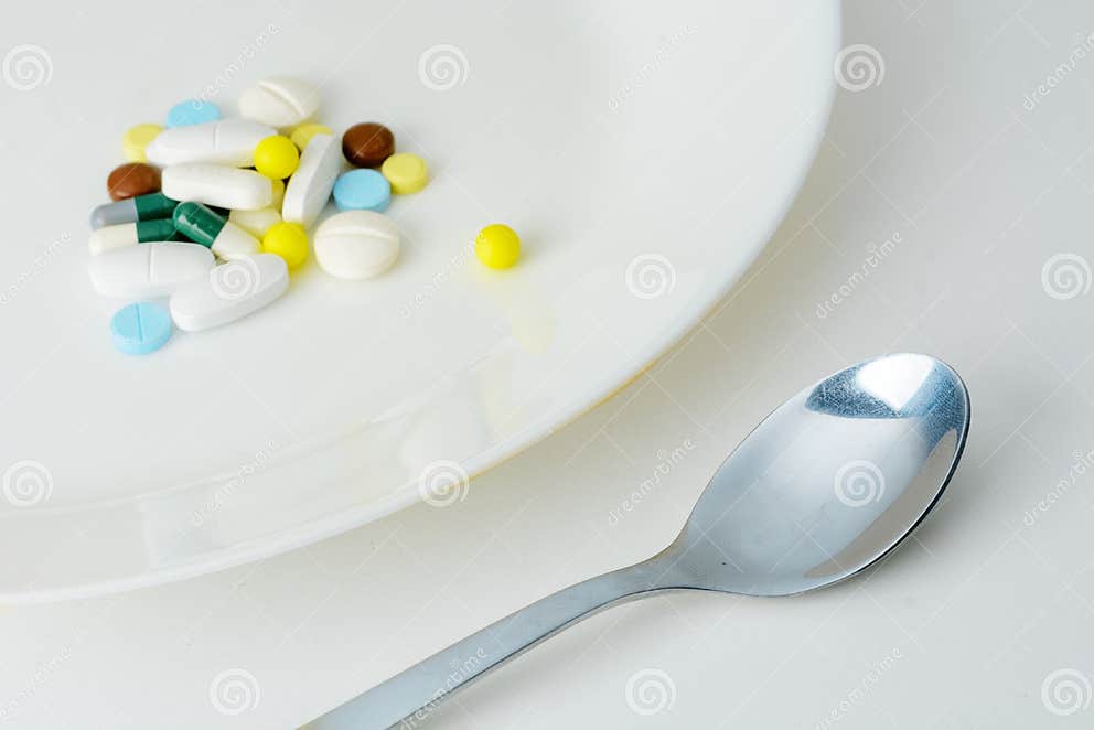 Spoon and the White Plate with Tablets of Different Shapes, Sizes and ...