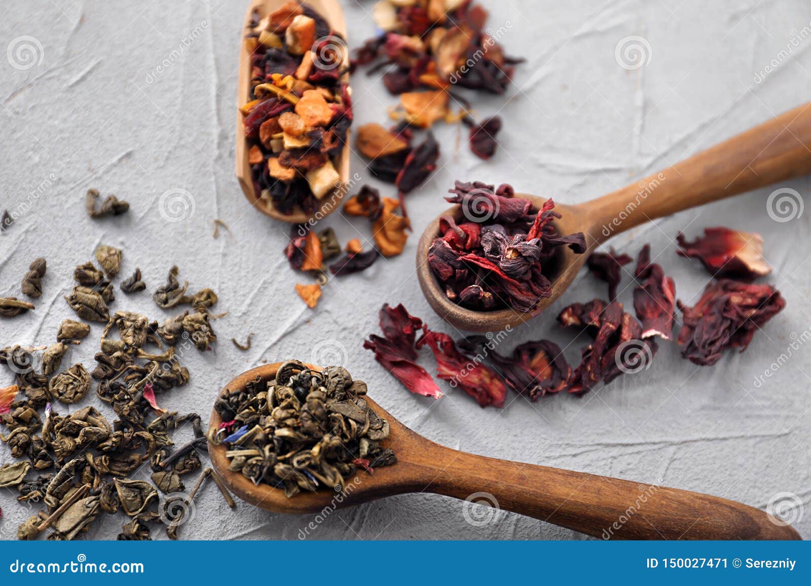 Spoons with Different Types of Dry Tea Leaves on Light Background Stock ...