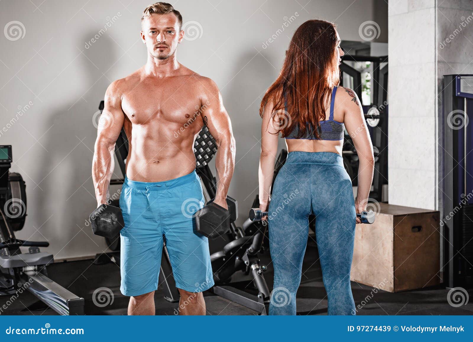 Sport Fit Couple at Gym. Work in Pairs with Dumbbells Stock Image ...