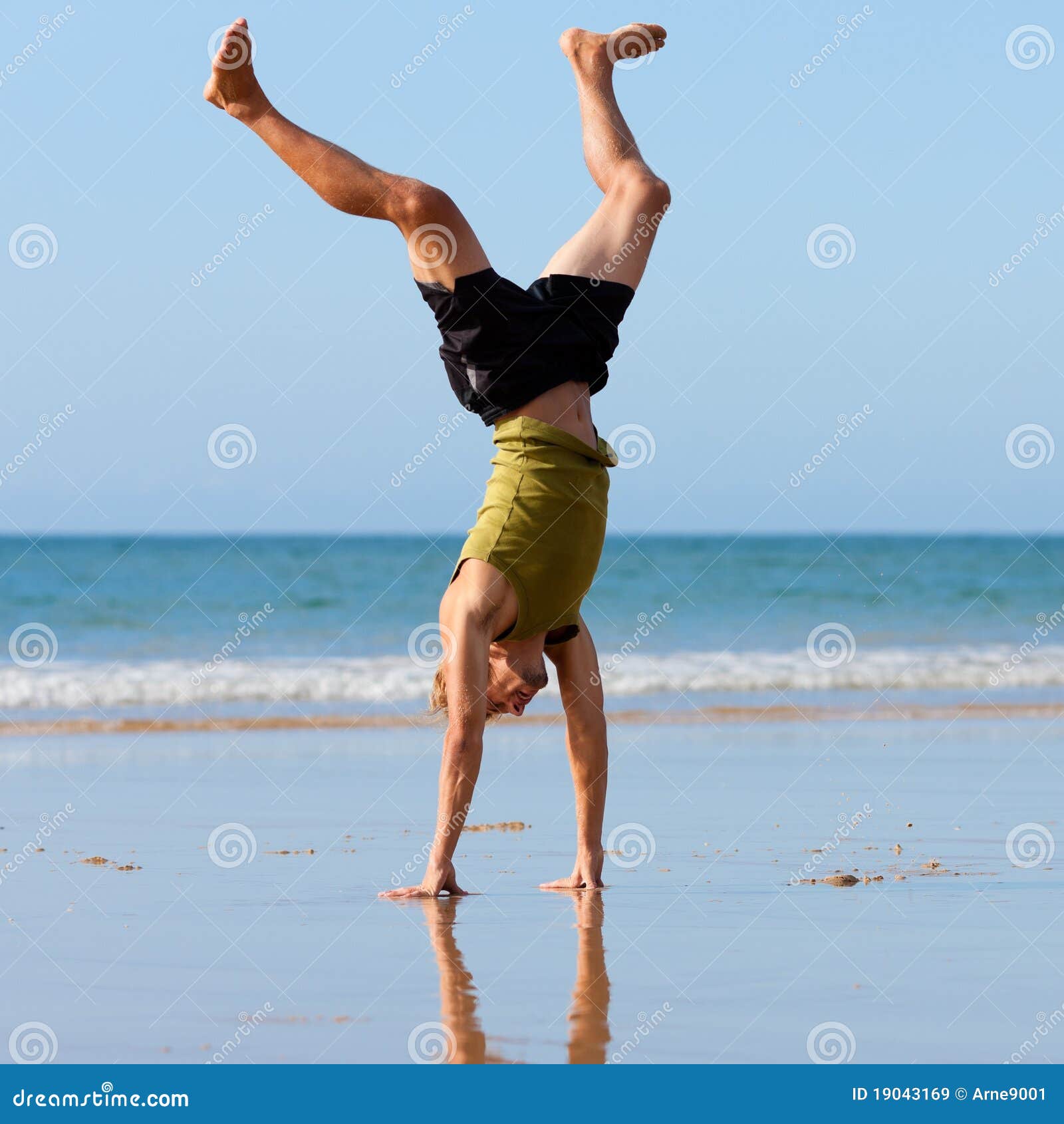 Sportive Man Doing Gymnastics on the Beach Stock Image - Image of ...