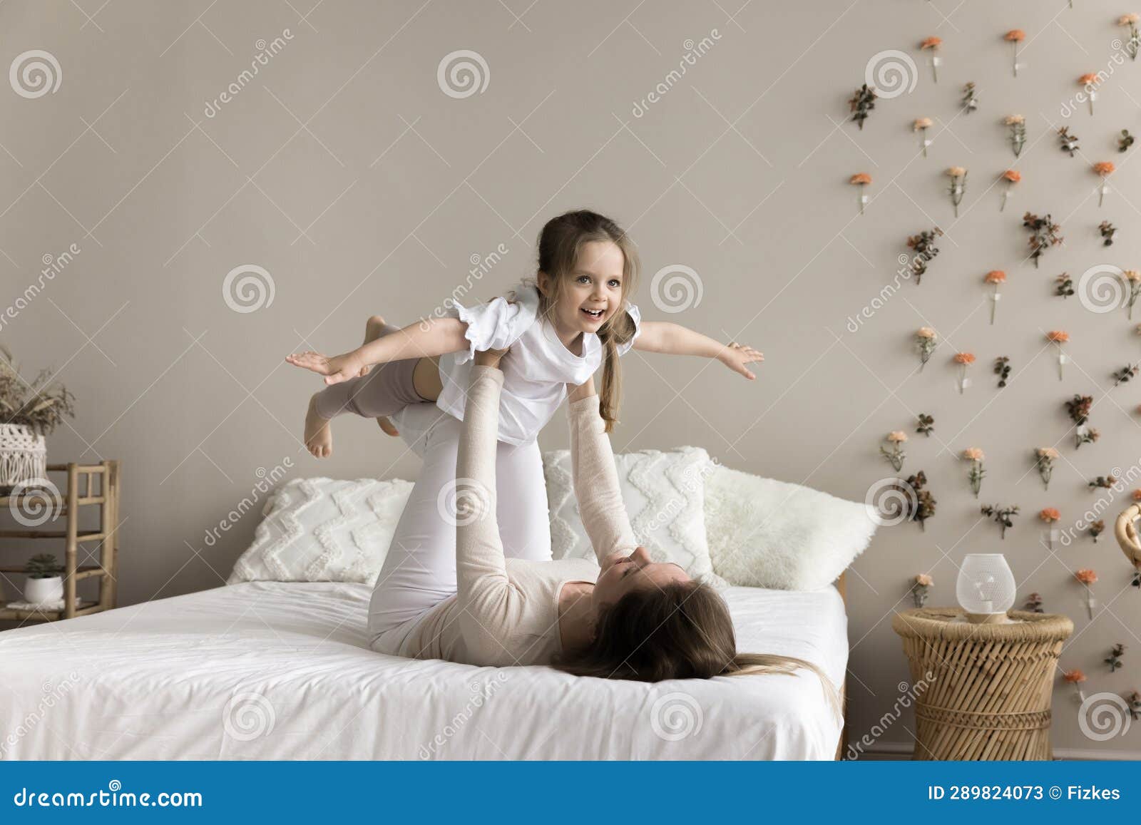Sportive Strong Mom Lifting Kid in Air, Supporting Child Stock Image ...