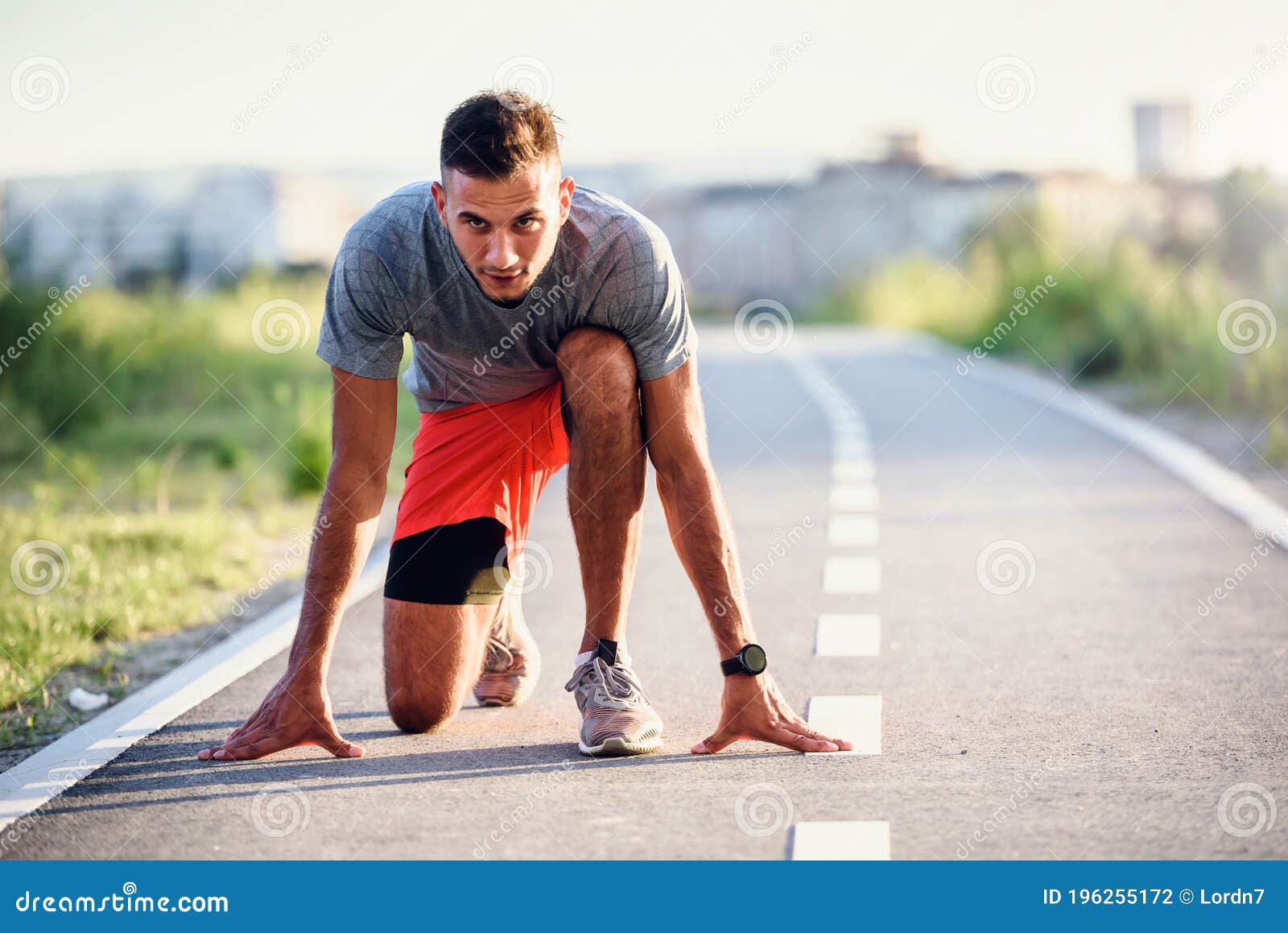 Sports Man Runner with Smart Watch in Start Position Preparing To Run ... Sports Man Runner with Smart Watch in Start Position Preparing To Run ...