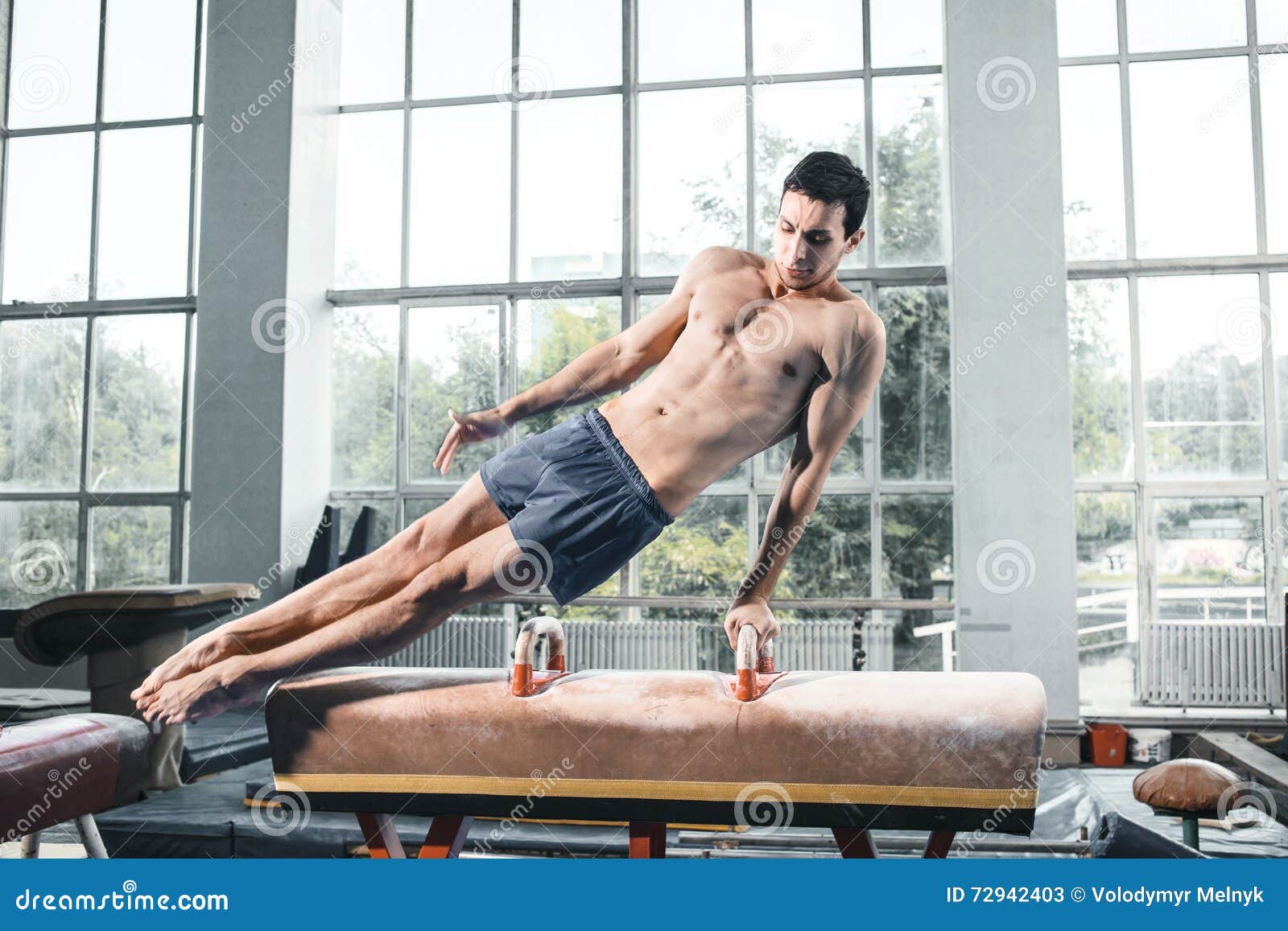 The Sportsman during Difficult Exercise, Sports Gymnastics Stock Image ...