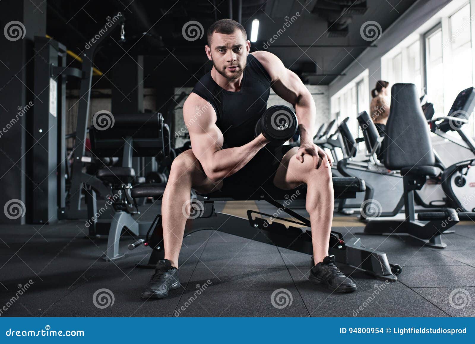 Sportsman Doing Biceps Workout with Dumbbell while Looking at Camera ...