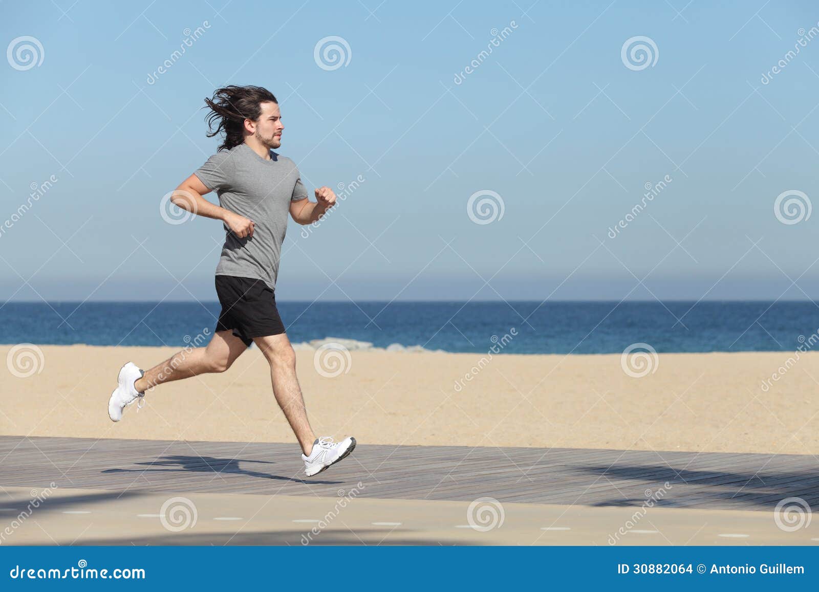 Sportsman Running on the Seafront of the Beach Stock Photo - Image of ...