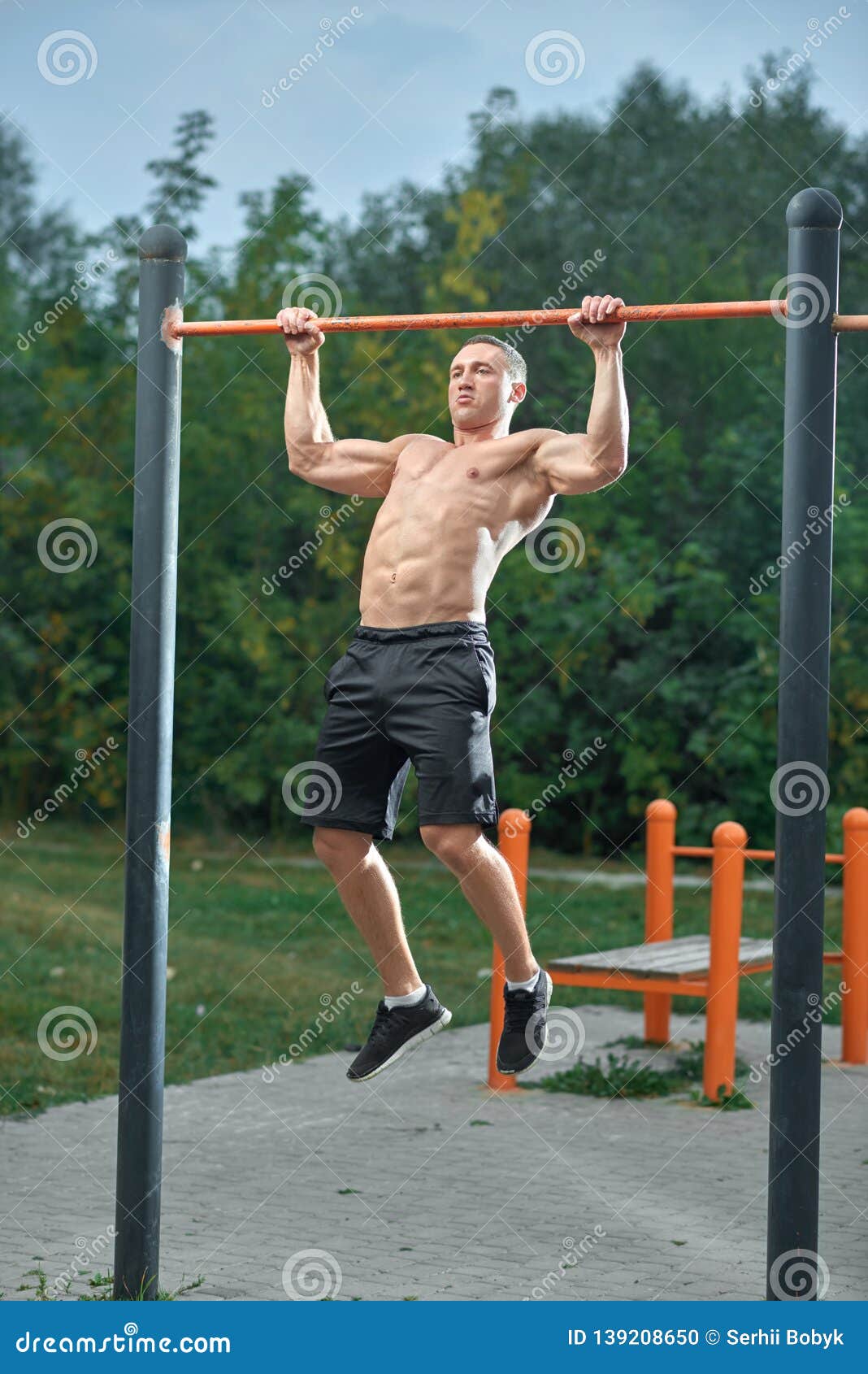 Sportsman Working Out Outdoors, Doing Pull Ups. Stock Photo - Image of ...