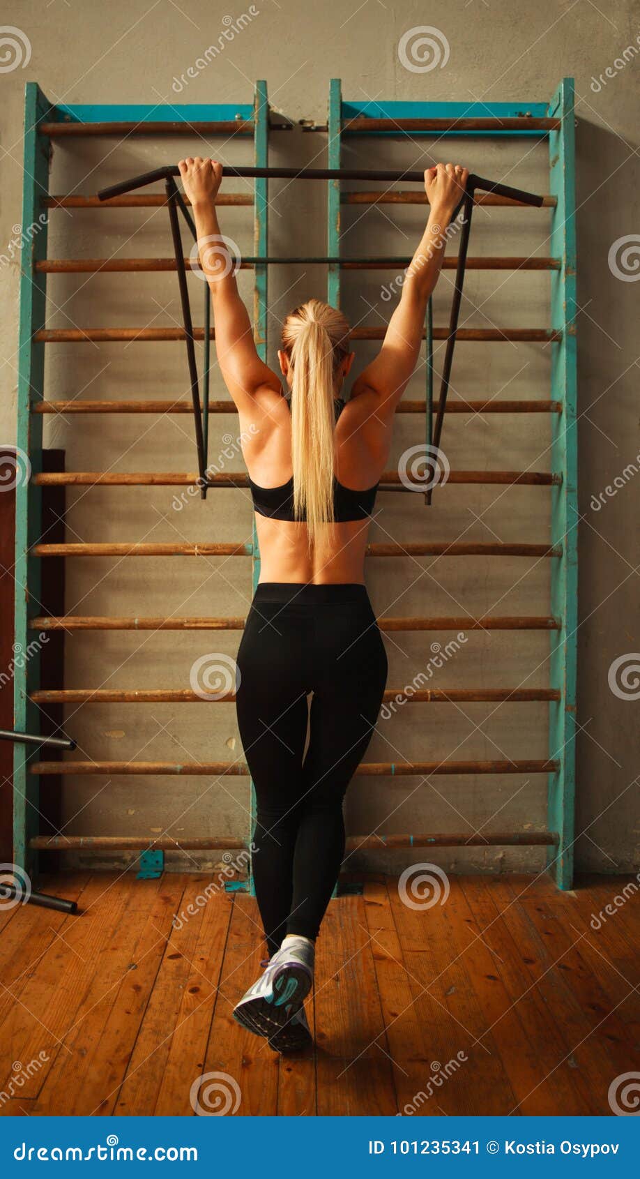 Sporty Athlete Woman Exercising Doing Pull-ups in Gym from Back Stock ...