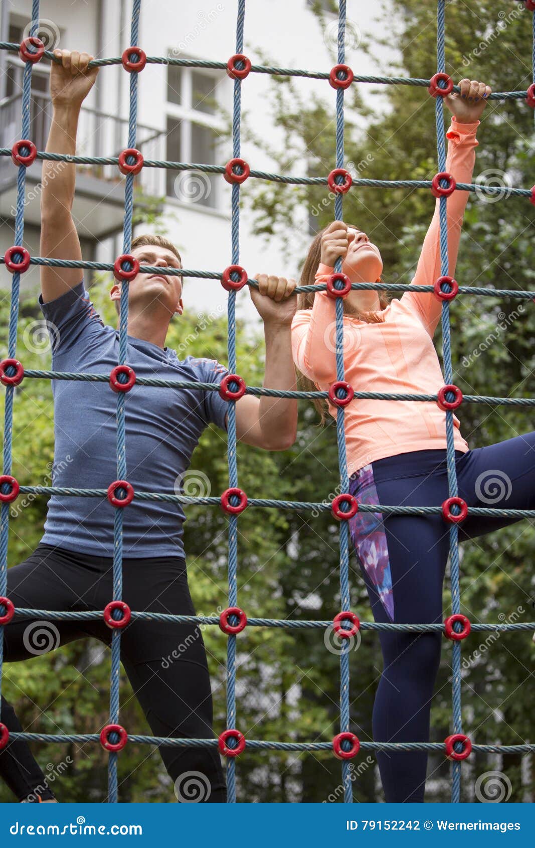 Sporty Couple Climbing Up a Net Stock Photo - Image of handsome ...