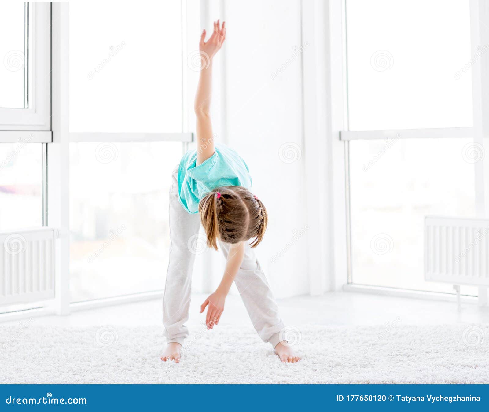 Sporty Girl Doing Windmill Exercise Stock Photo - Image of little ...
