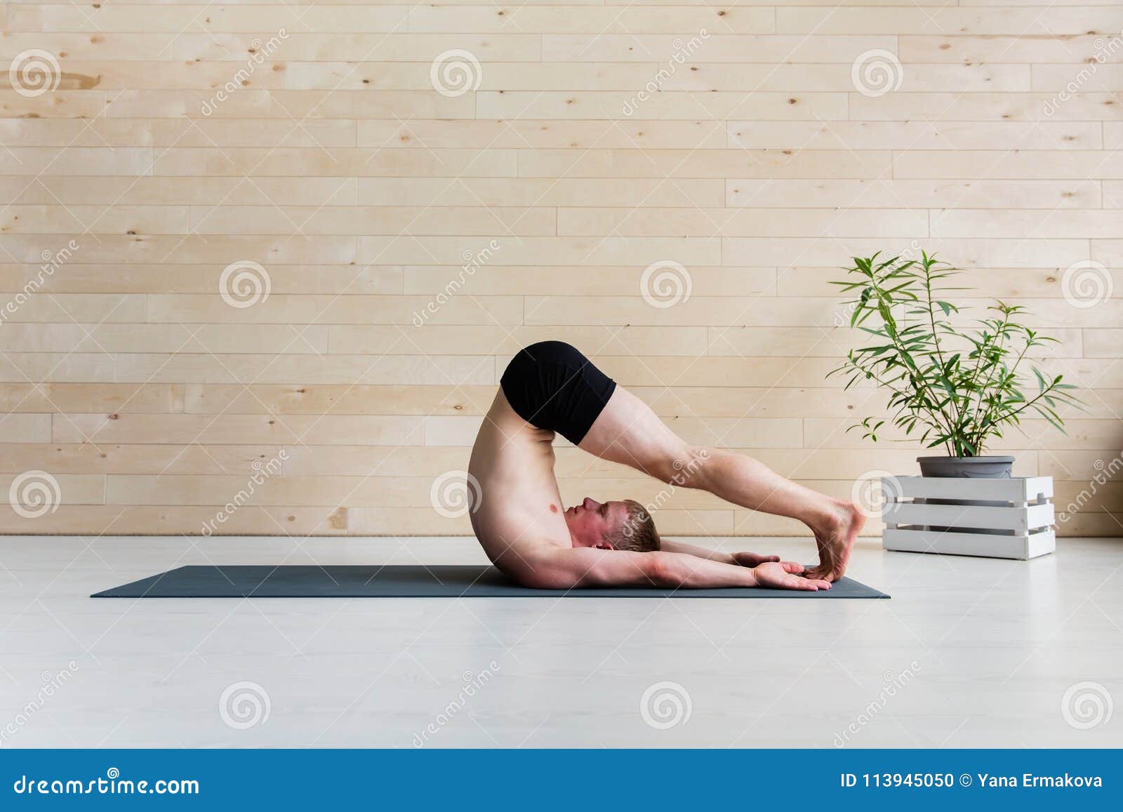 Sporty man practicing yoga stock photo. Image of ashtanga - 113945050