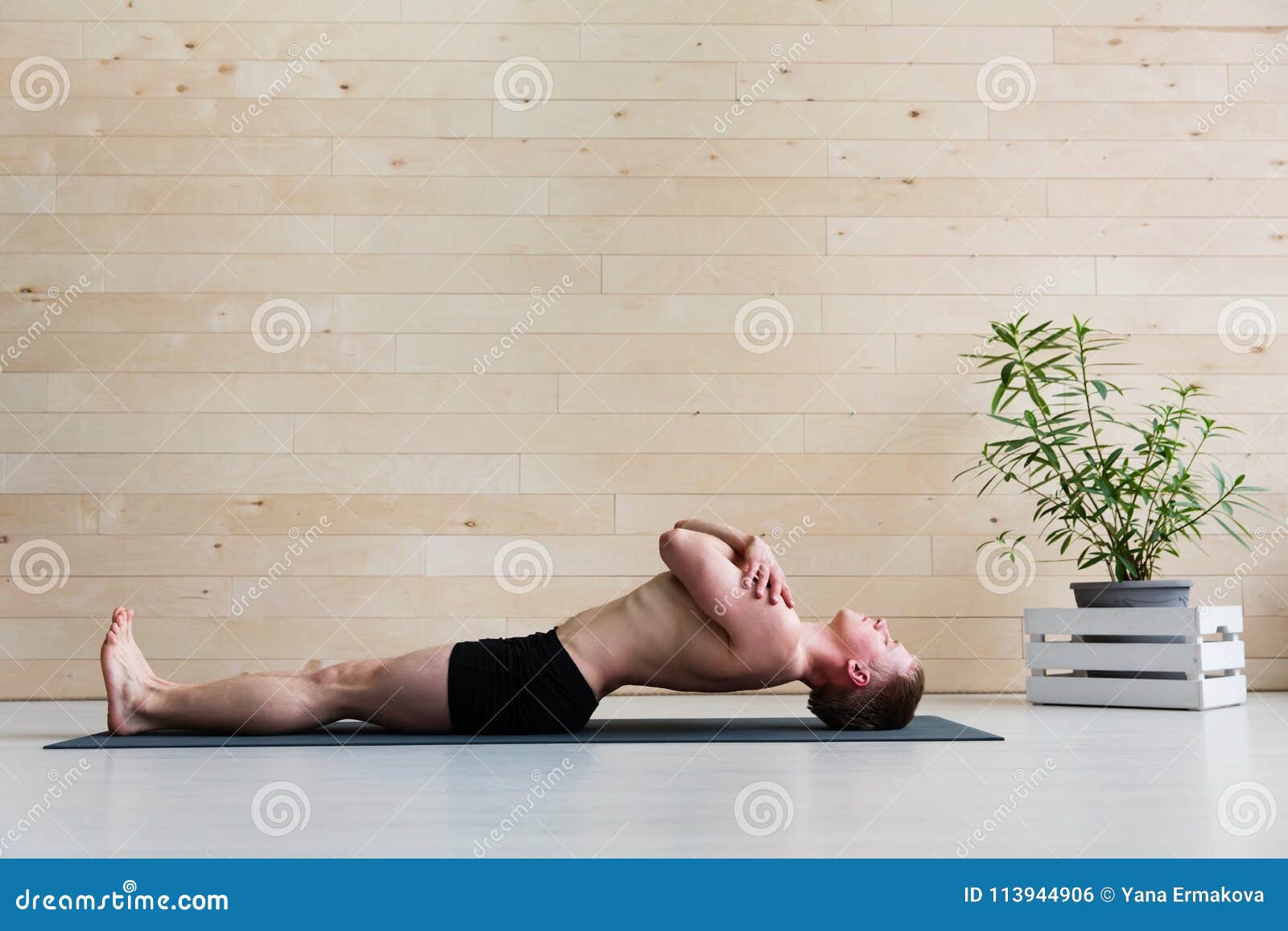 Sporty man practicing yoga stock photo. Image of activity - 113944906