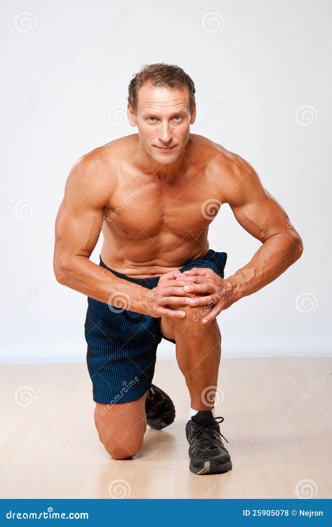 Sporty Man in Shorts on His Knee Stock Photo - Image of male, body ...