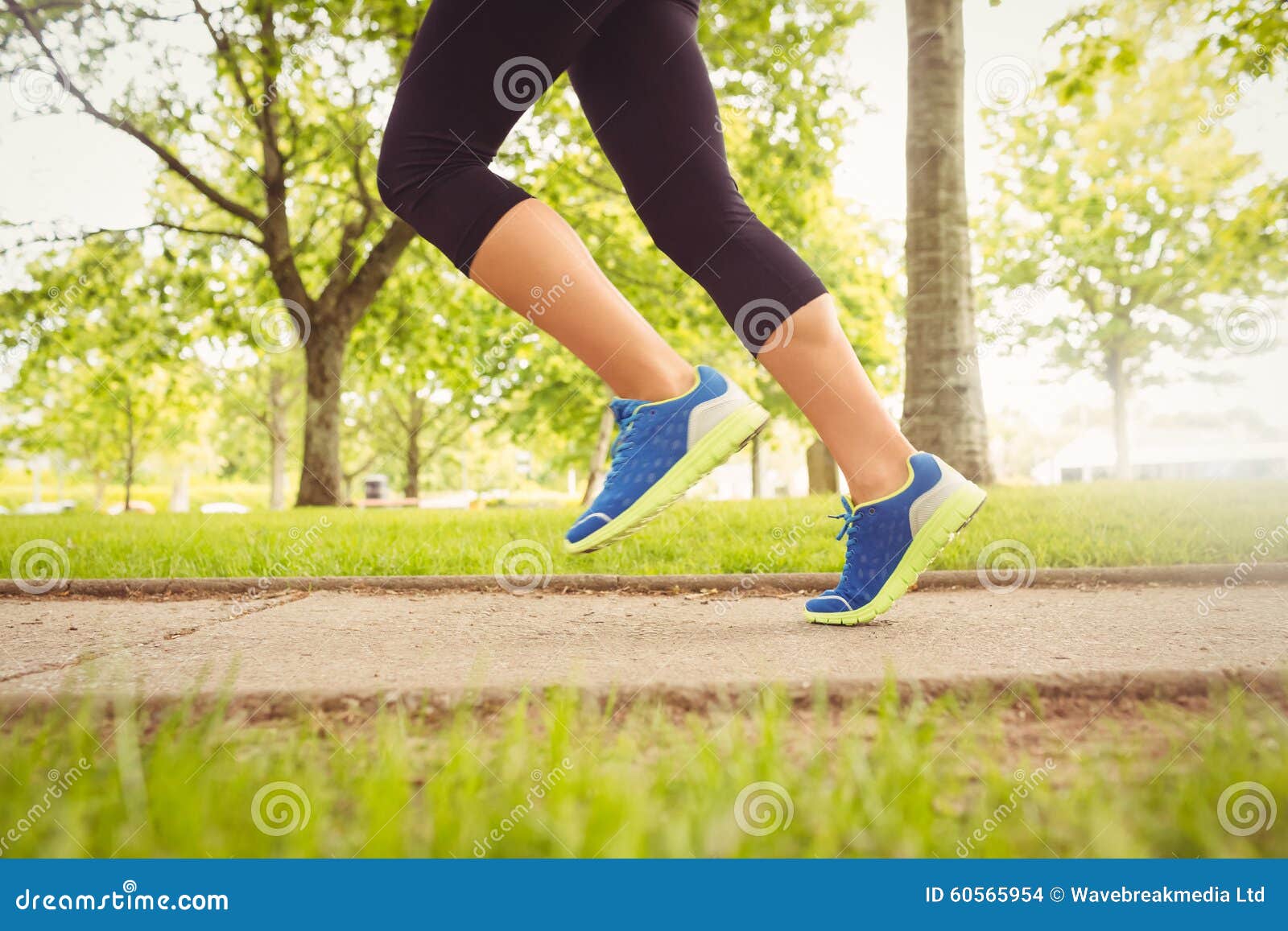 Sporty Woman Jogging in Park Stock Photo - Image of focus, health: 60565954