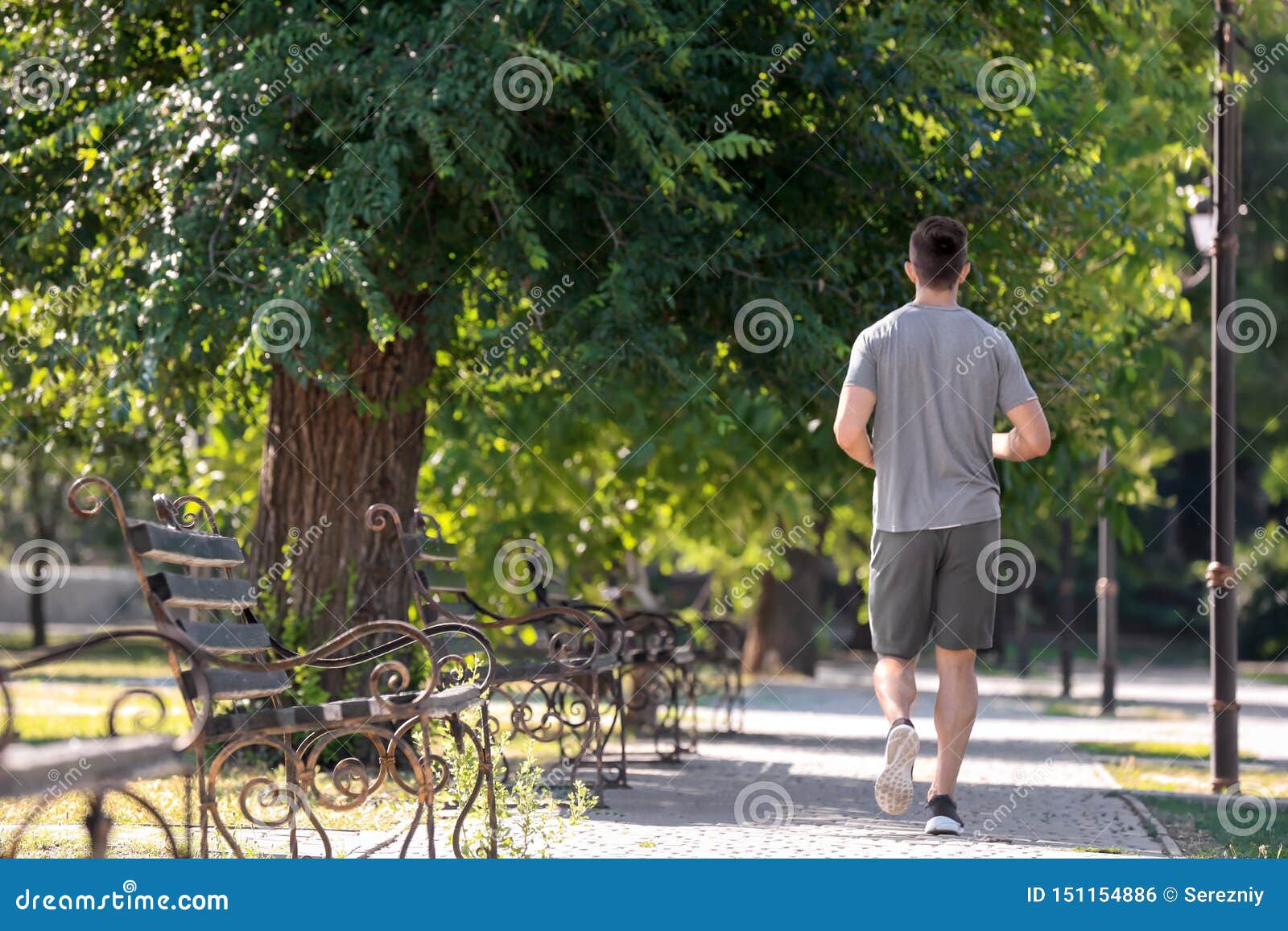 Sporty Young Man Running in Park Stock Photo - Image of energy, city ...