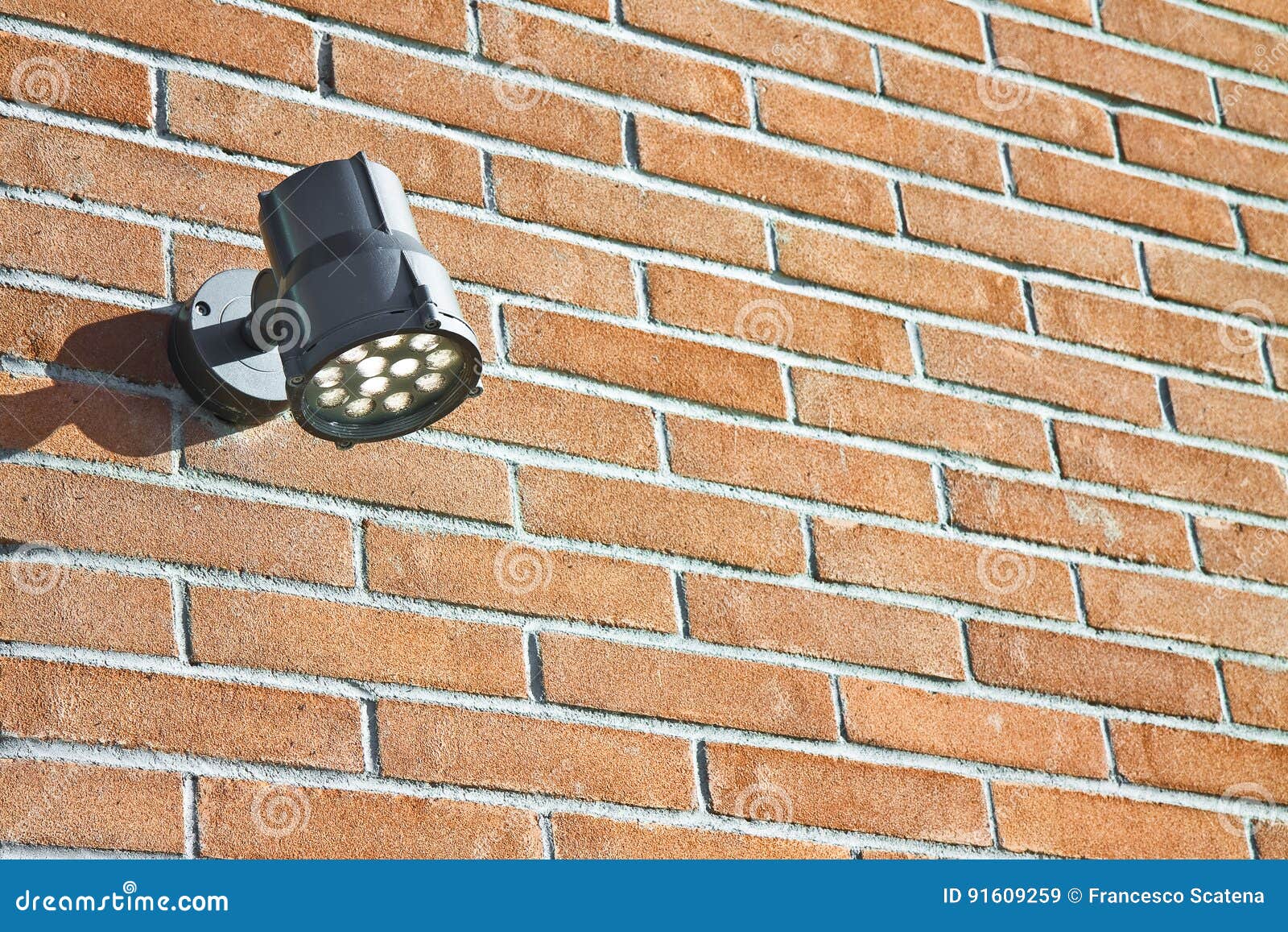Spotlight Against a New Brick Wall - Image with Copy Space Stock Image ...
